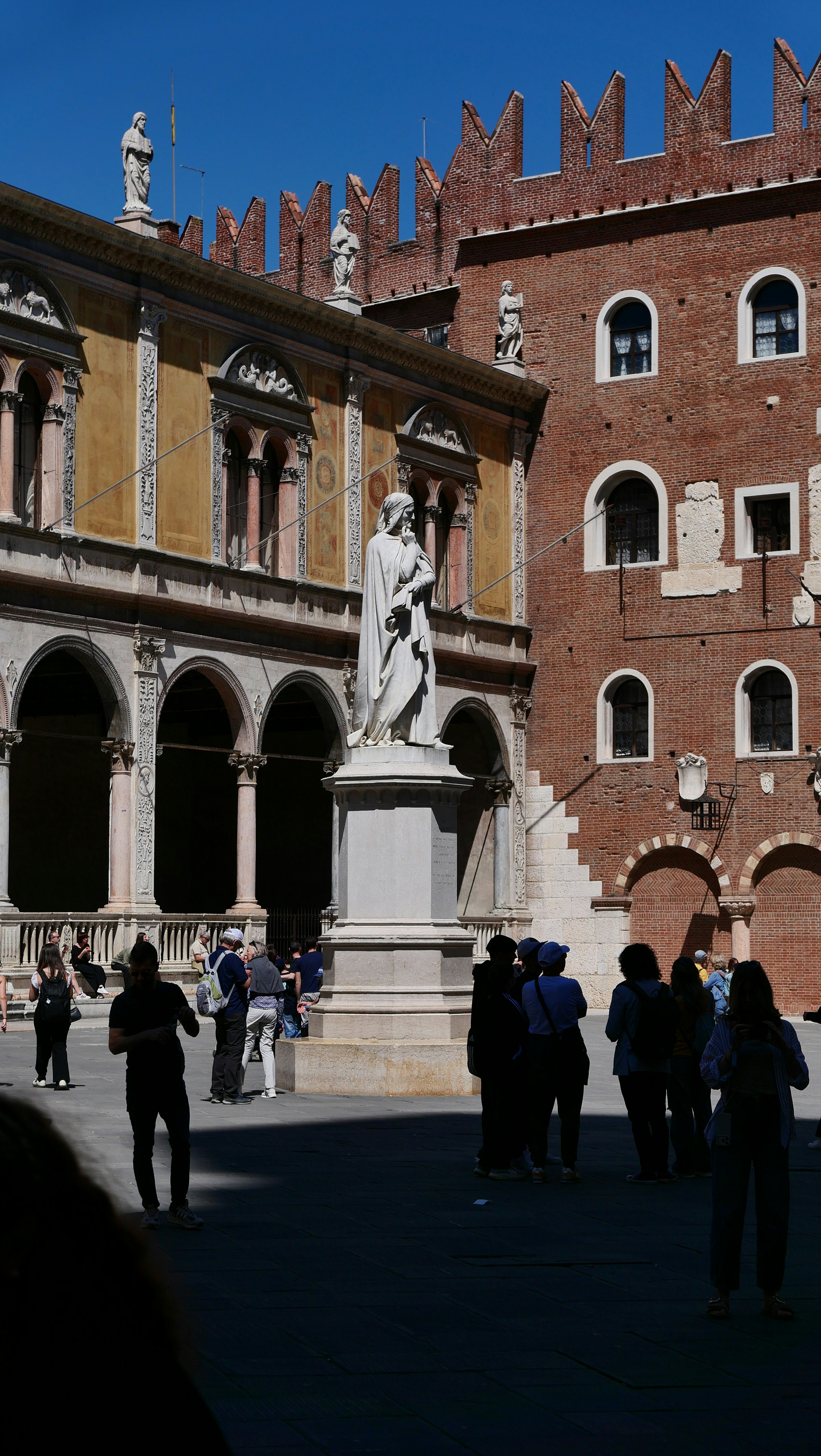 Statue Square: Sunlit Courtyard Amid Historic Brickwork