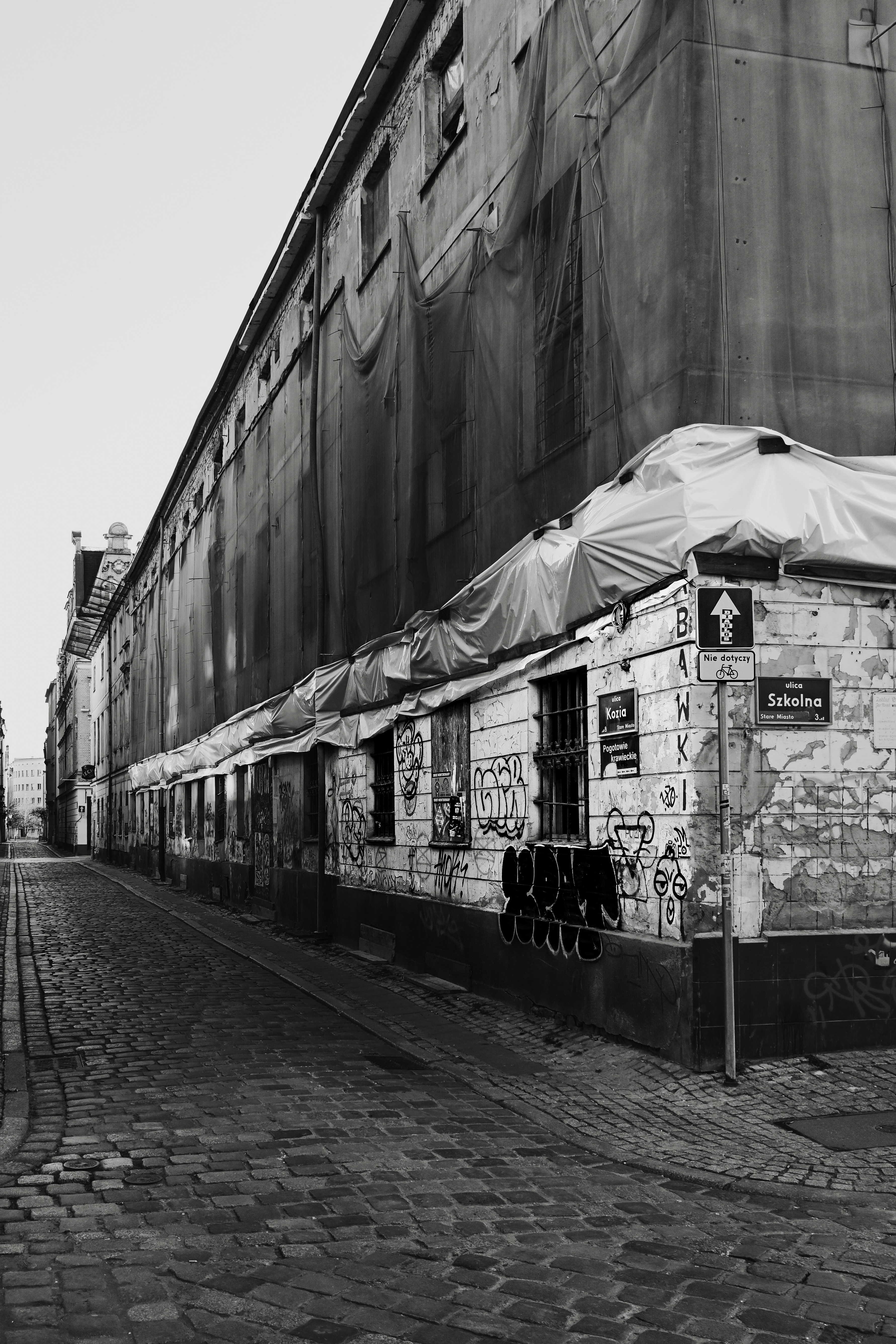 Worn Facade of a Cobblestone Street Donned in Shade