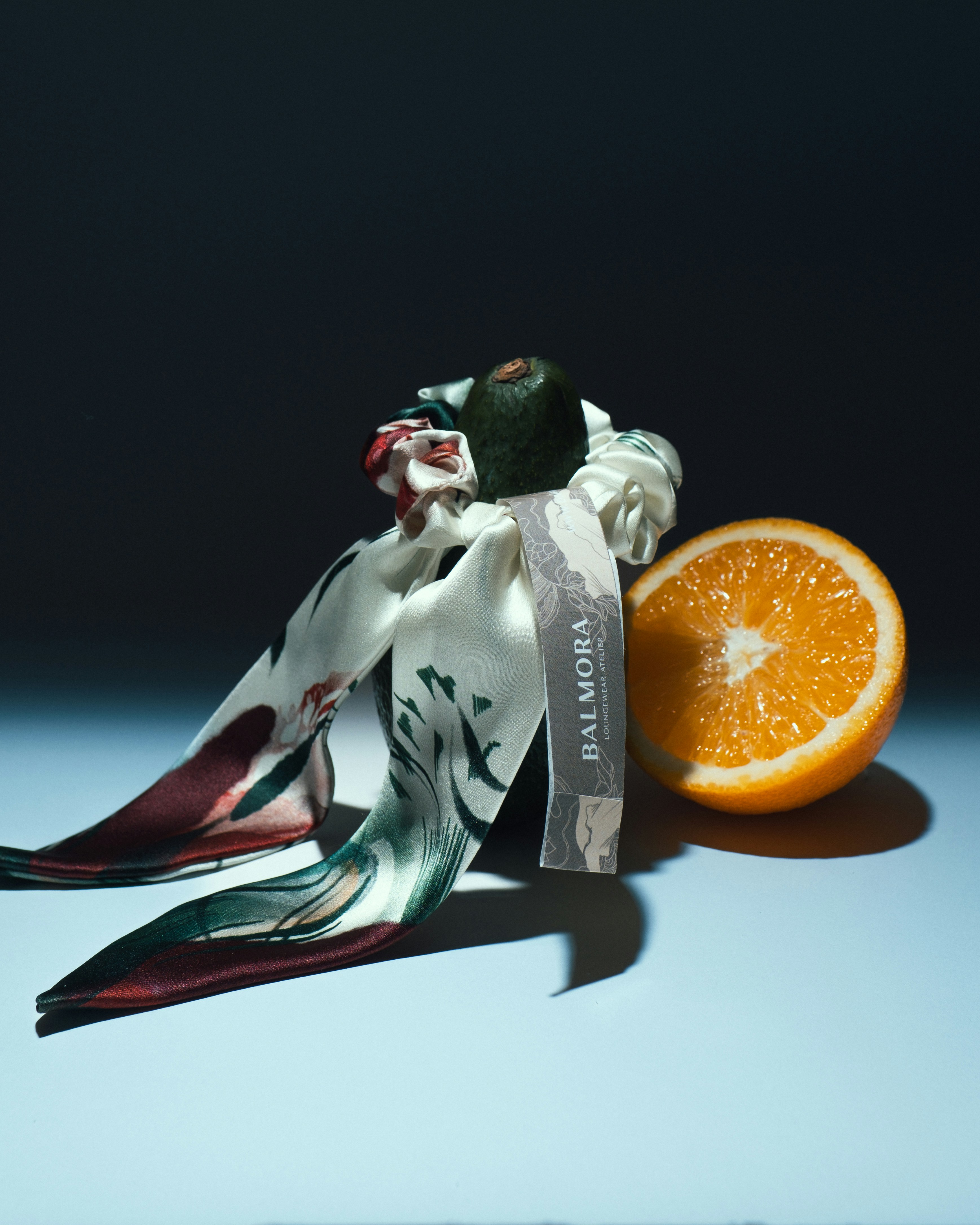 Silk Ribbon and Orange Slices: A Quiet Still Life Merges Textures