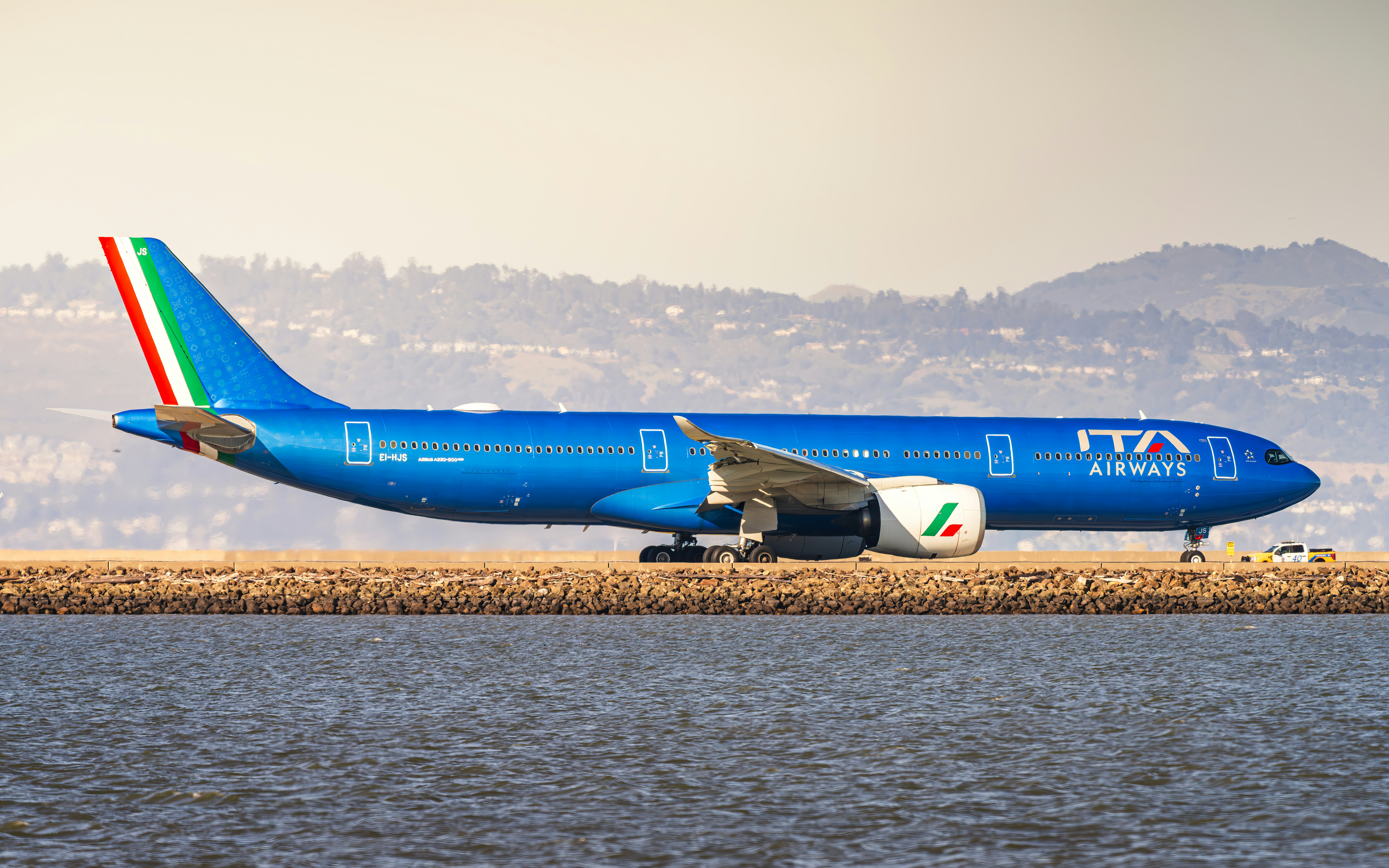 Bluebird at the Shoreline: ITA Airways A320 on a Calm Coastal Taxi