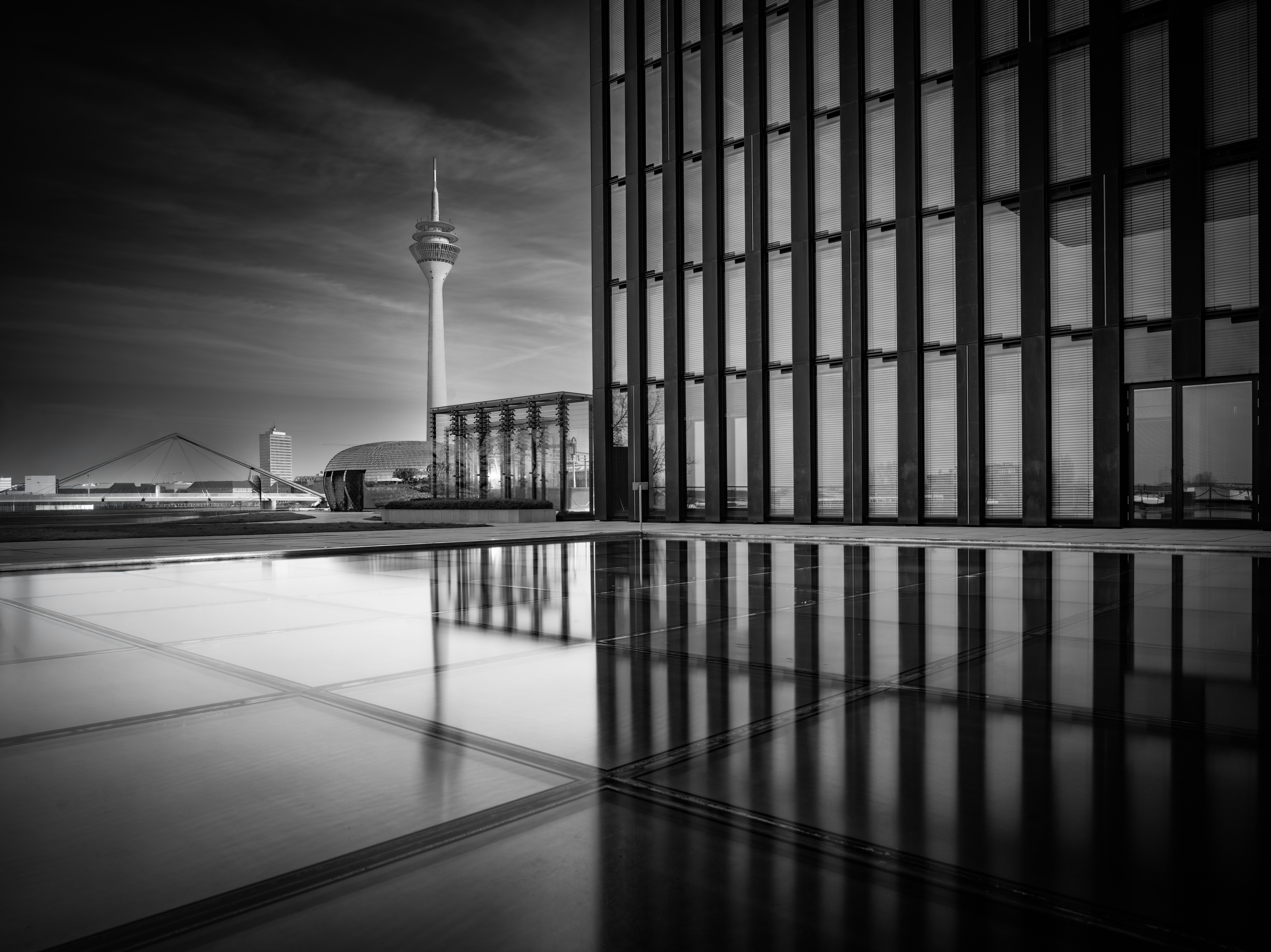 Reflections at the Edge: Towering Skyline Beyond a Glass Facade