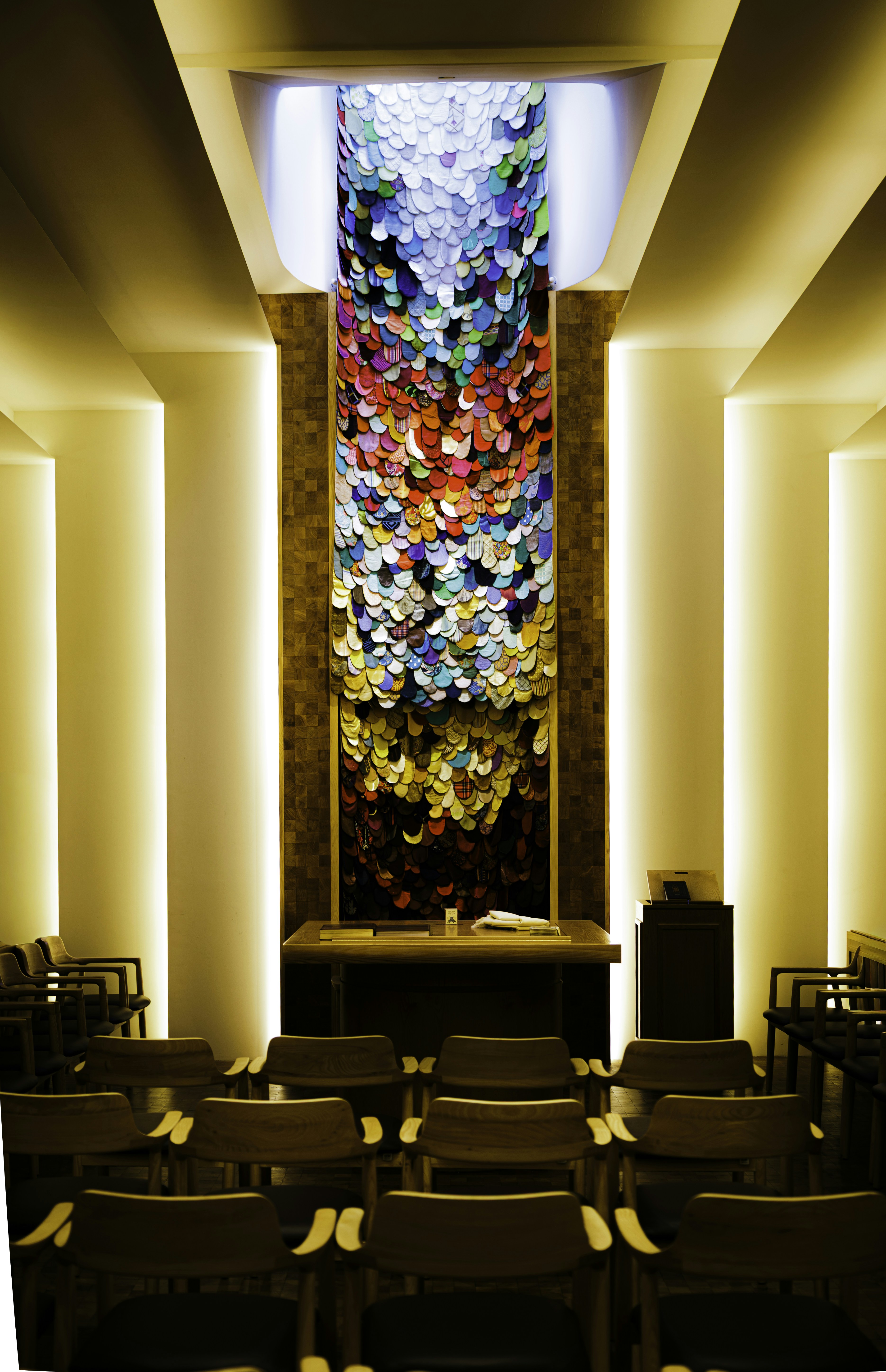 Colorful Tapestry Tower Rising Behind a Quiet Auditorium