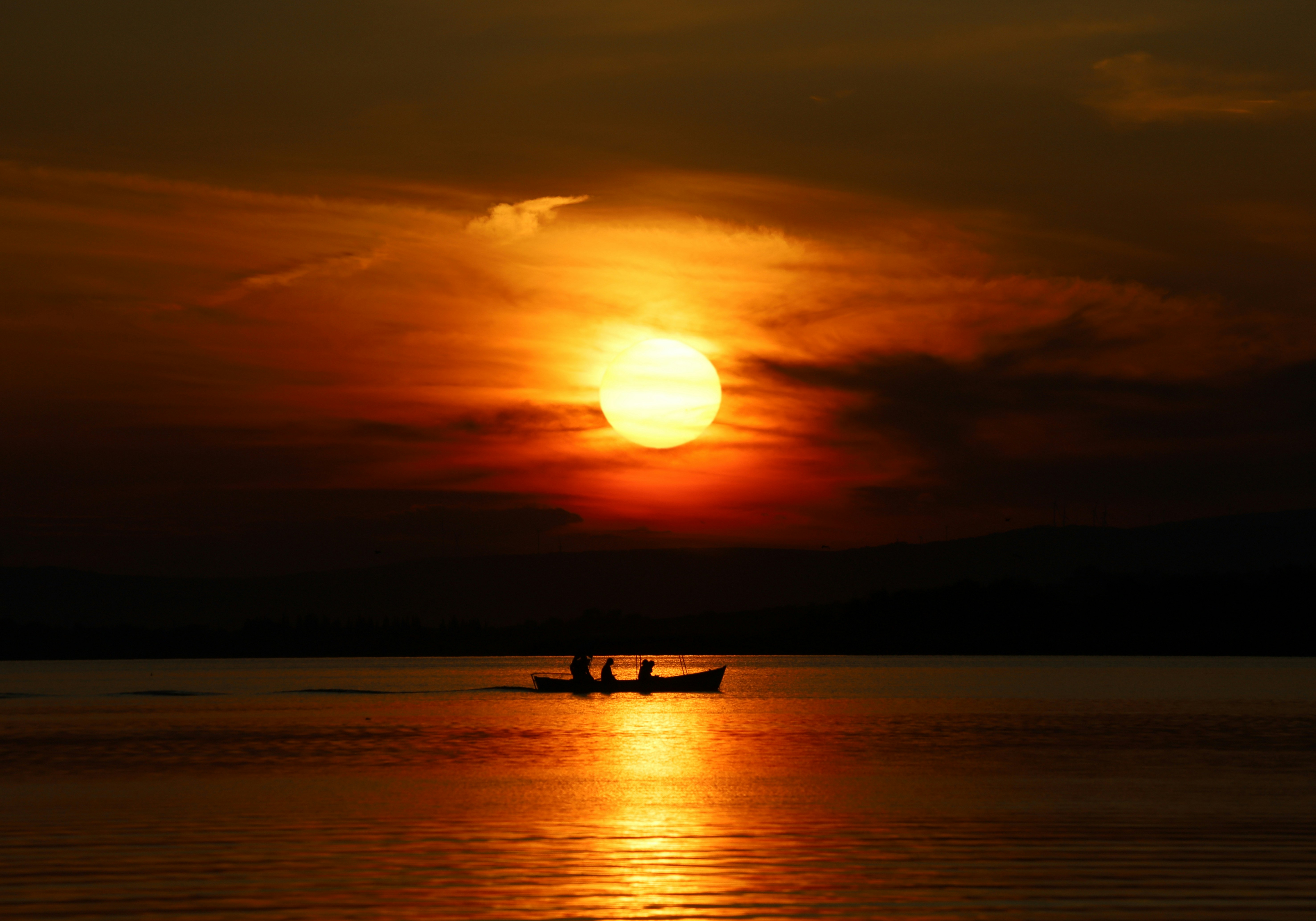 Sole Vessel at Sunset: A Quiet Boat on Quiet Waters