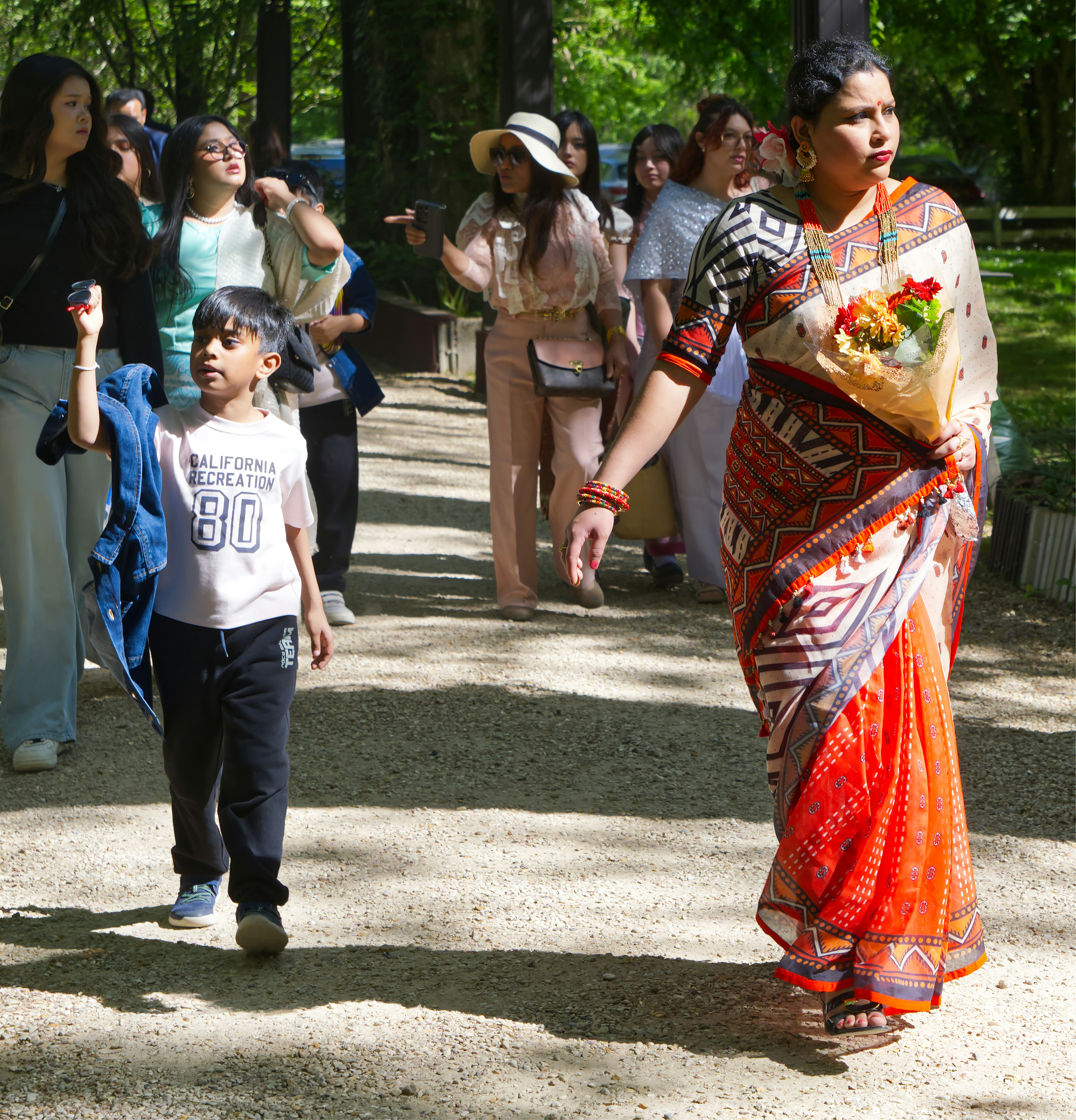 Sari-clad Traveler Leads a Momentary Parade Beside a Bouquet of People