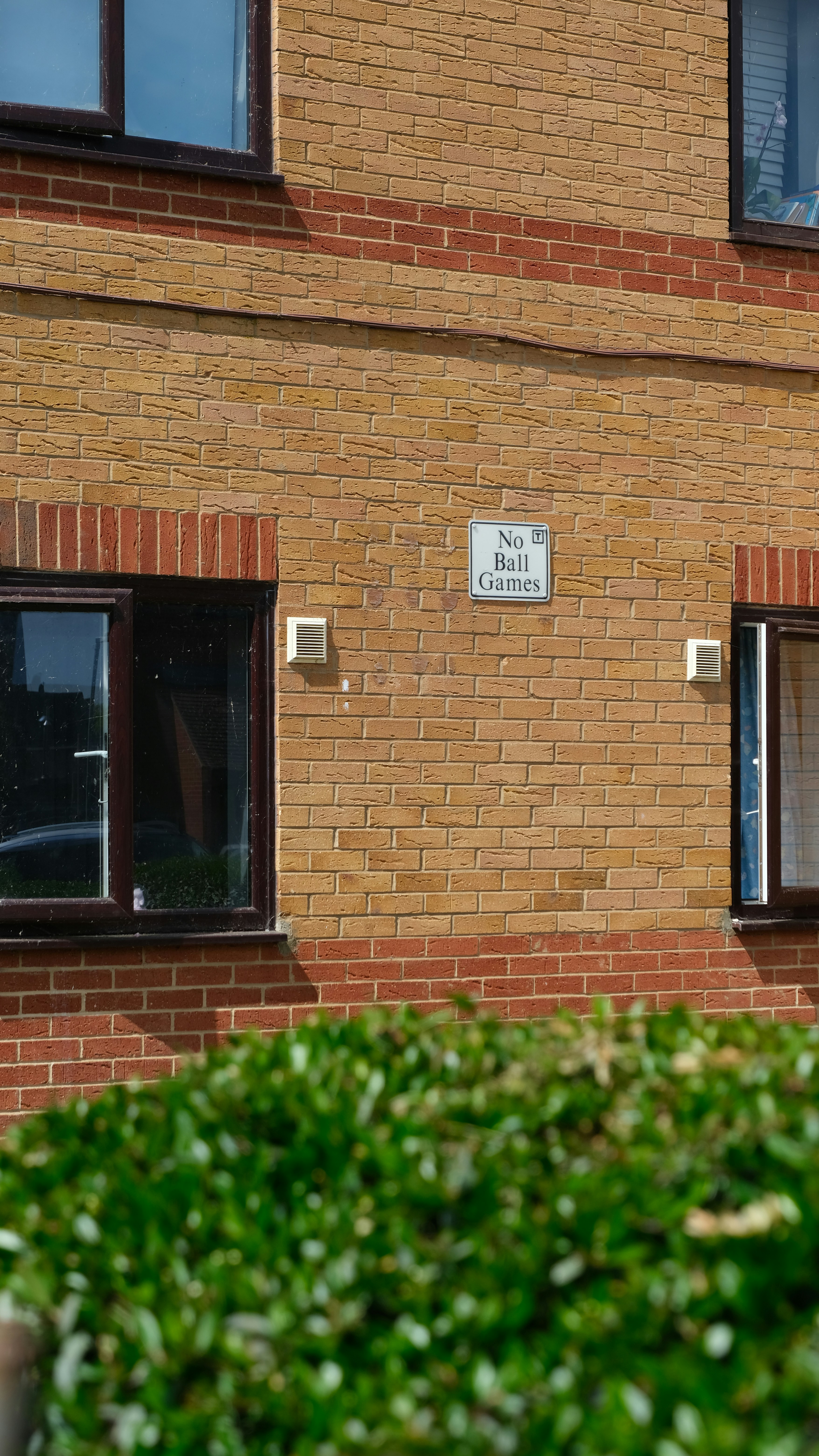 Brick Facade with No Ball Games Sign