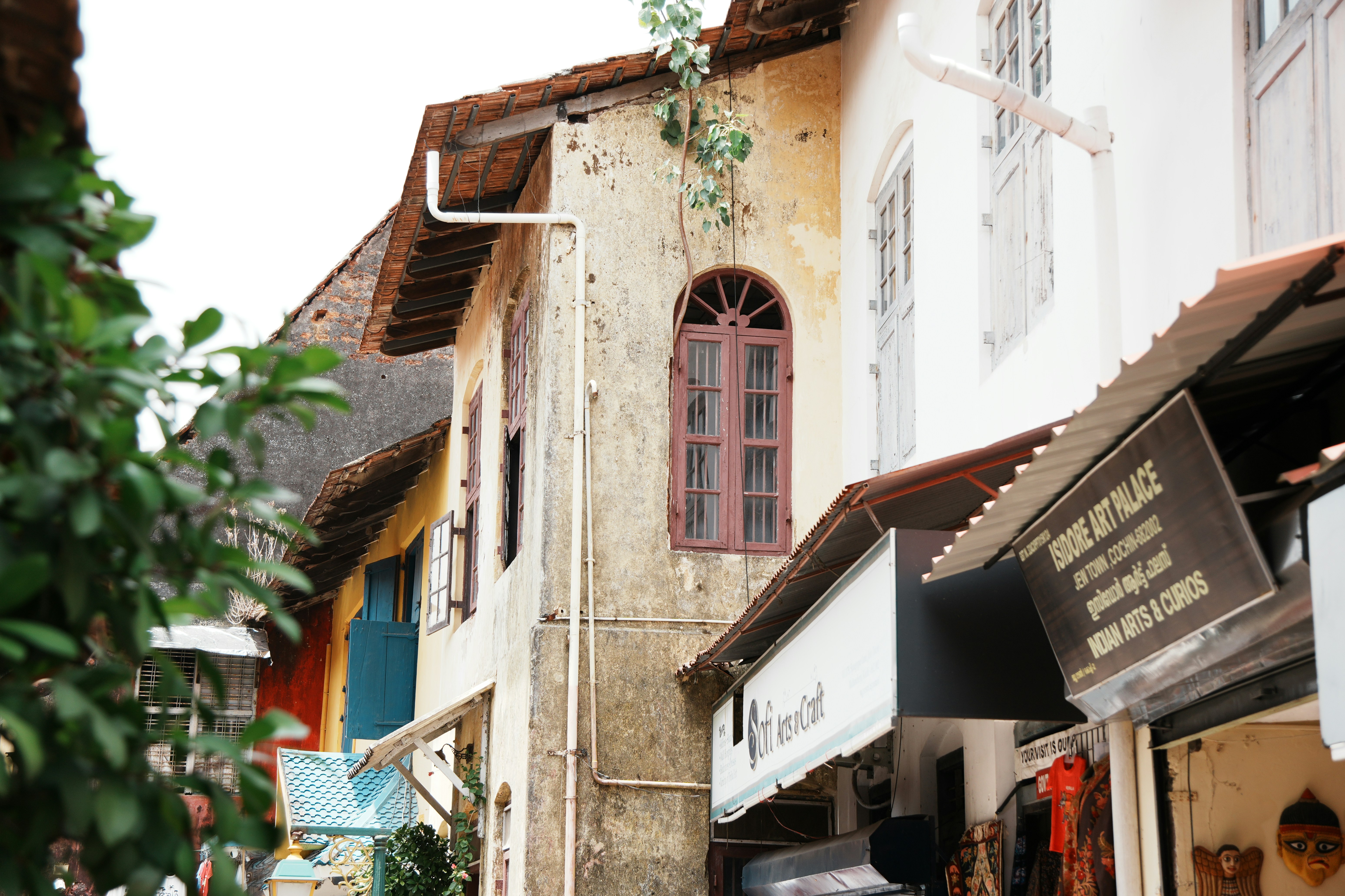 Sunlit street charm: A faded tower watches over a lively market