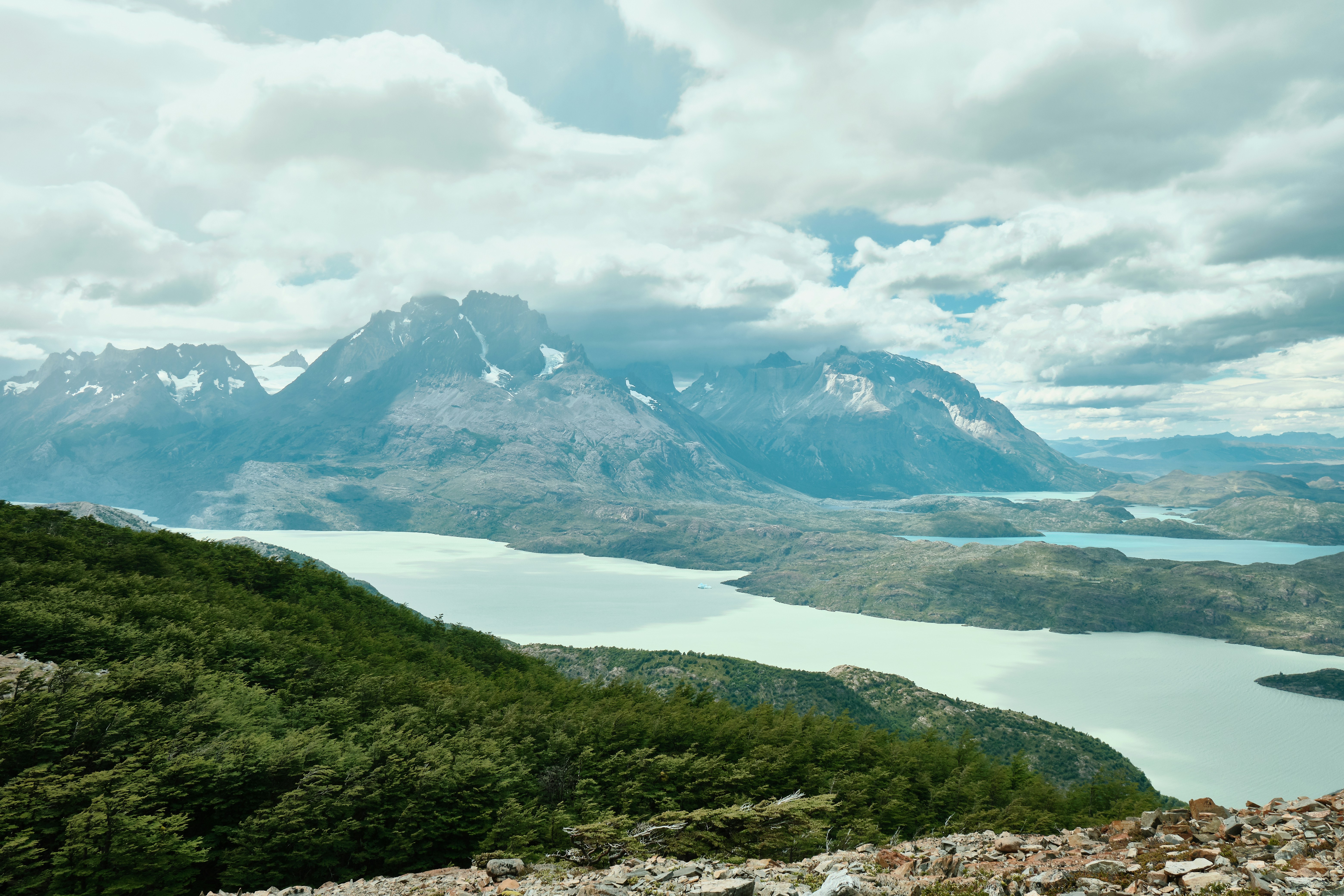 Verdant foothills and glacier-fed lake beneath jagged peaks