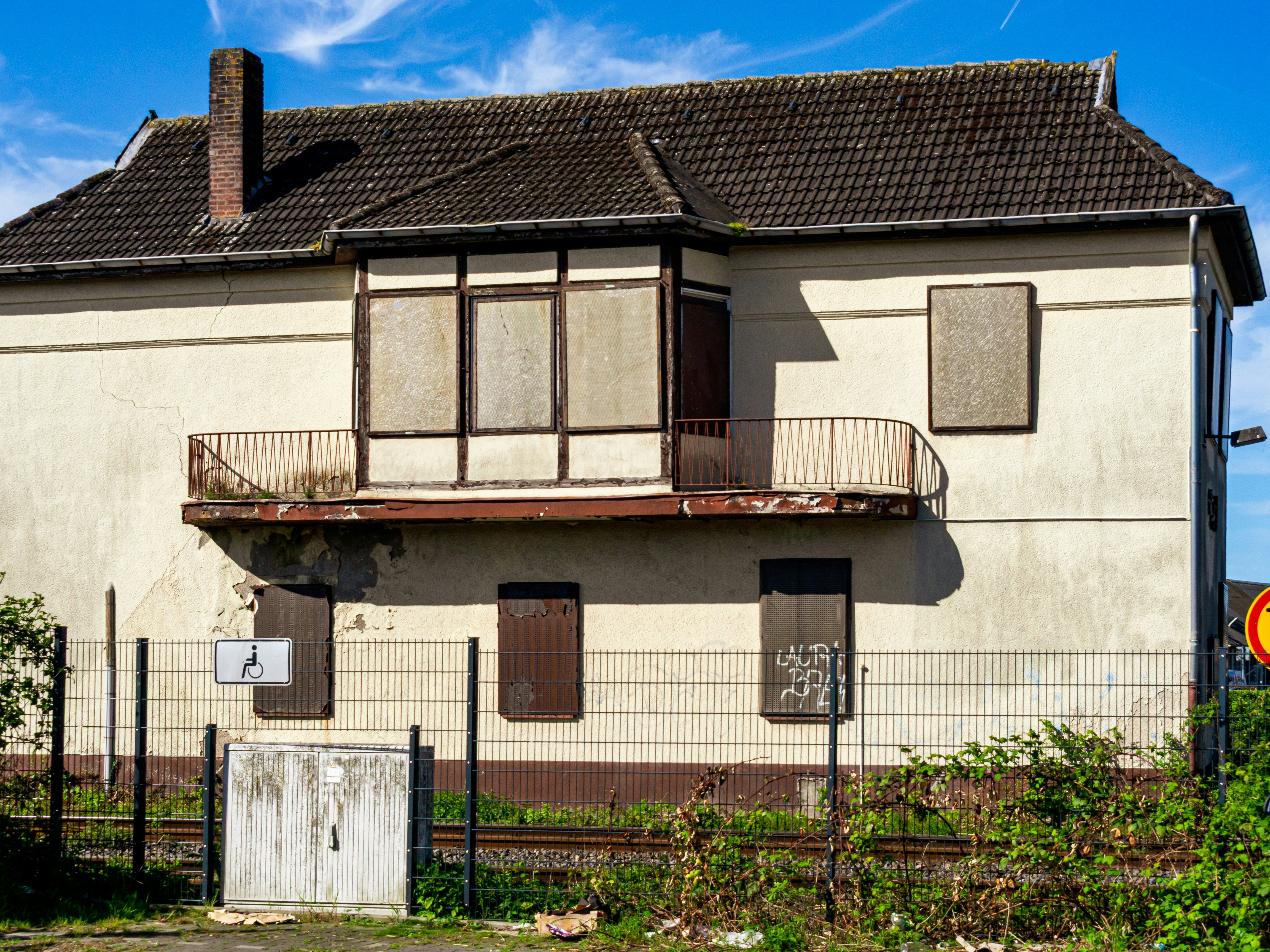 Abandoned Villa Facade with Balcony Overhang