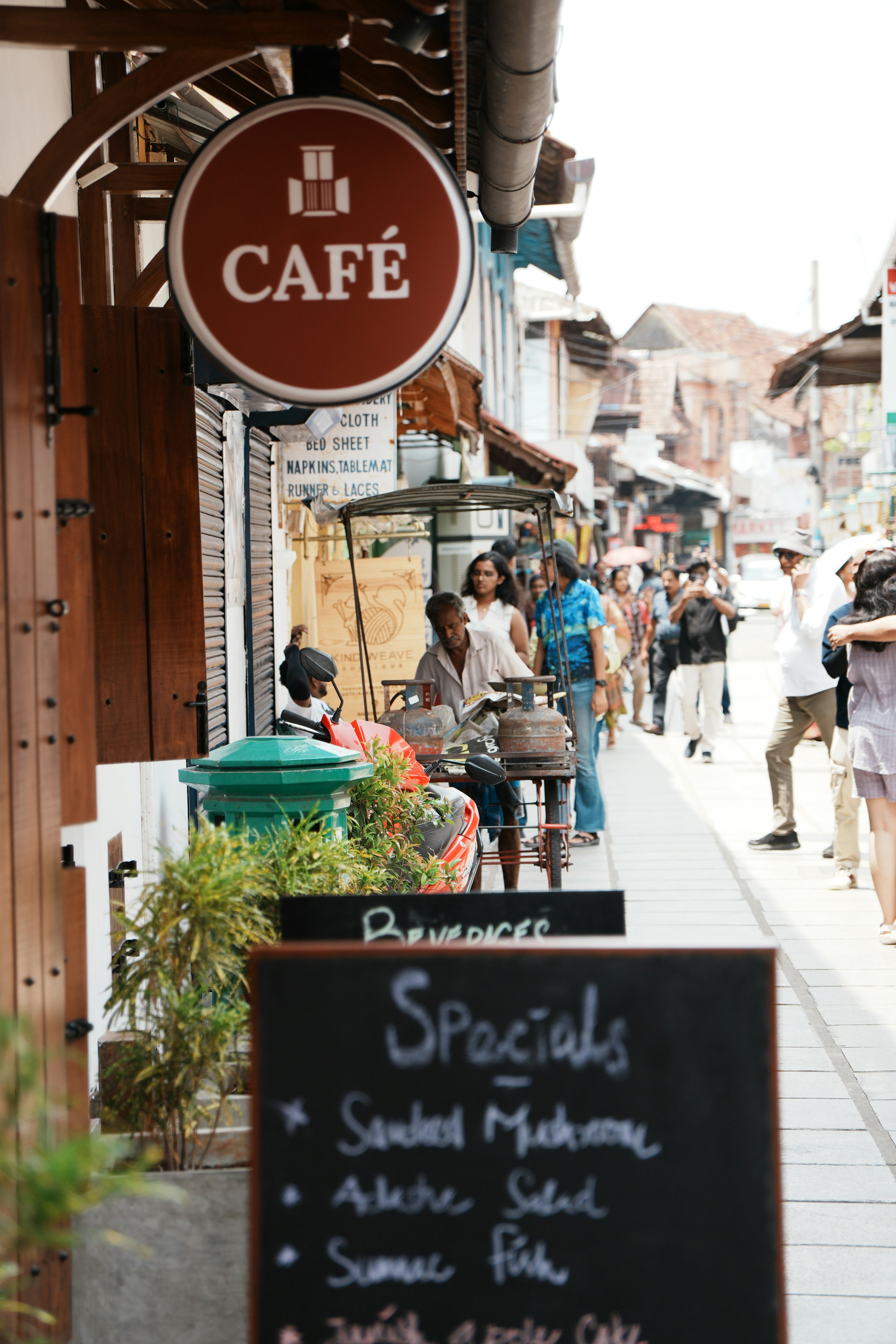 Cafe Signover and Street Scene: A Sunny Corridor of Chalkboard Specials