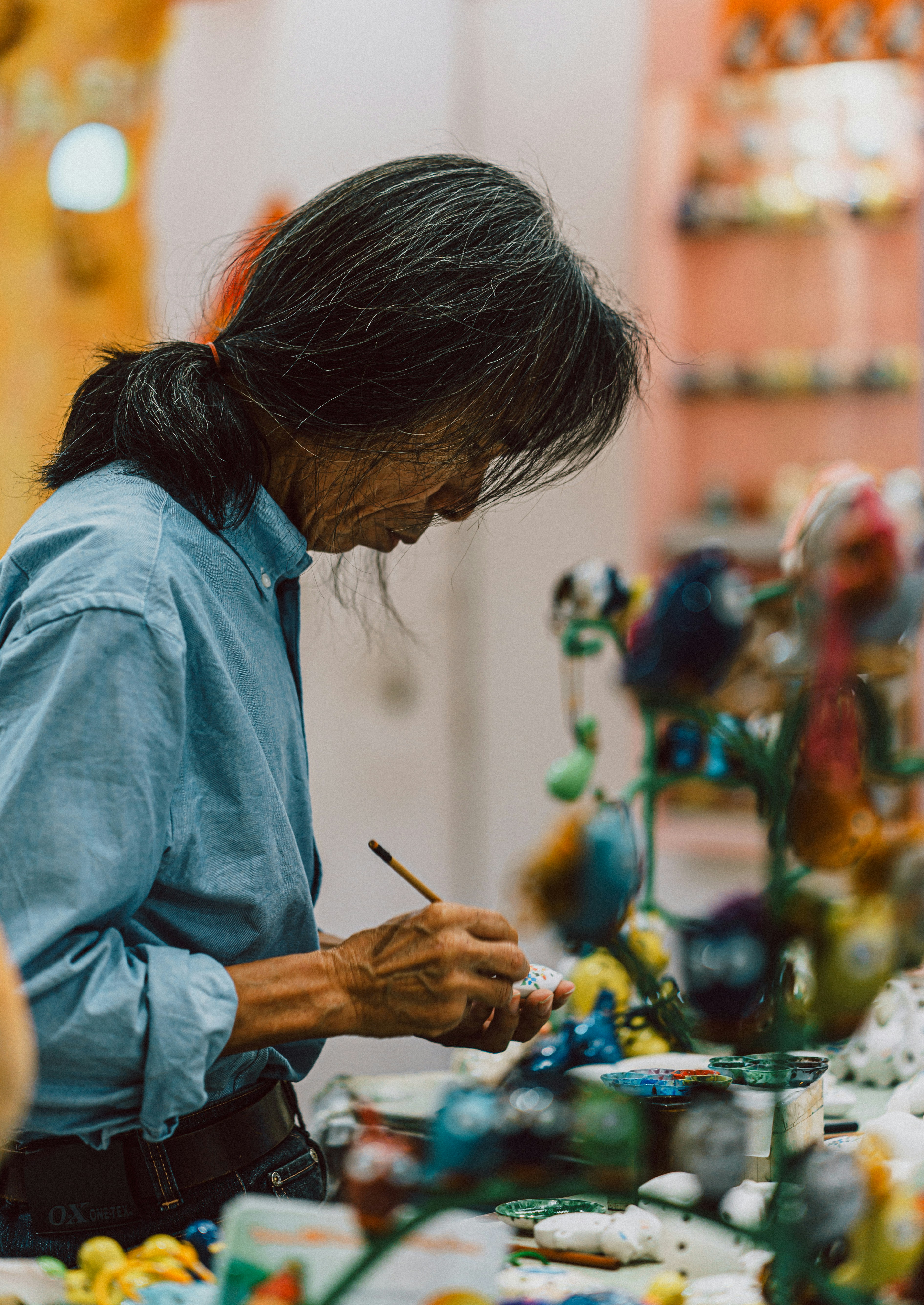 Portrait of a Painter at Work: Focused Hands and Brushwork in Soft Light