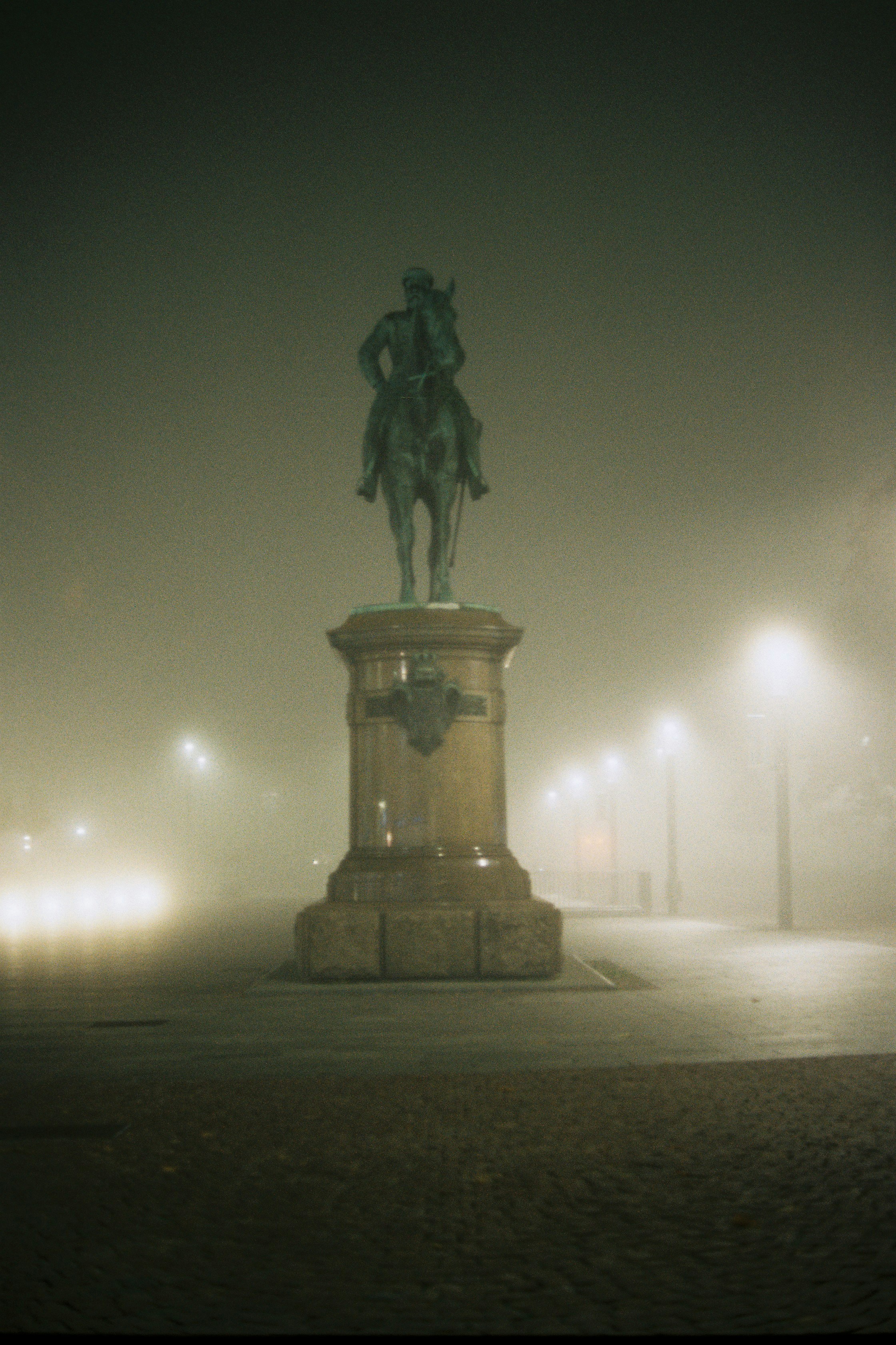 Mist Shrouded Equine Statue Amid Foggy Square
