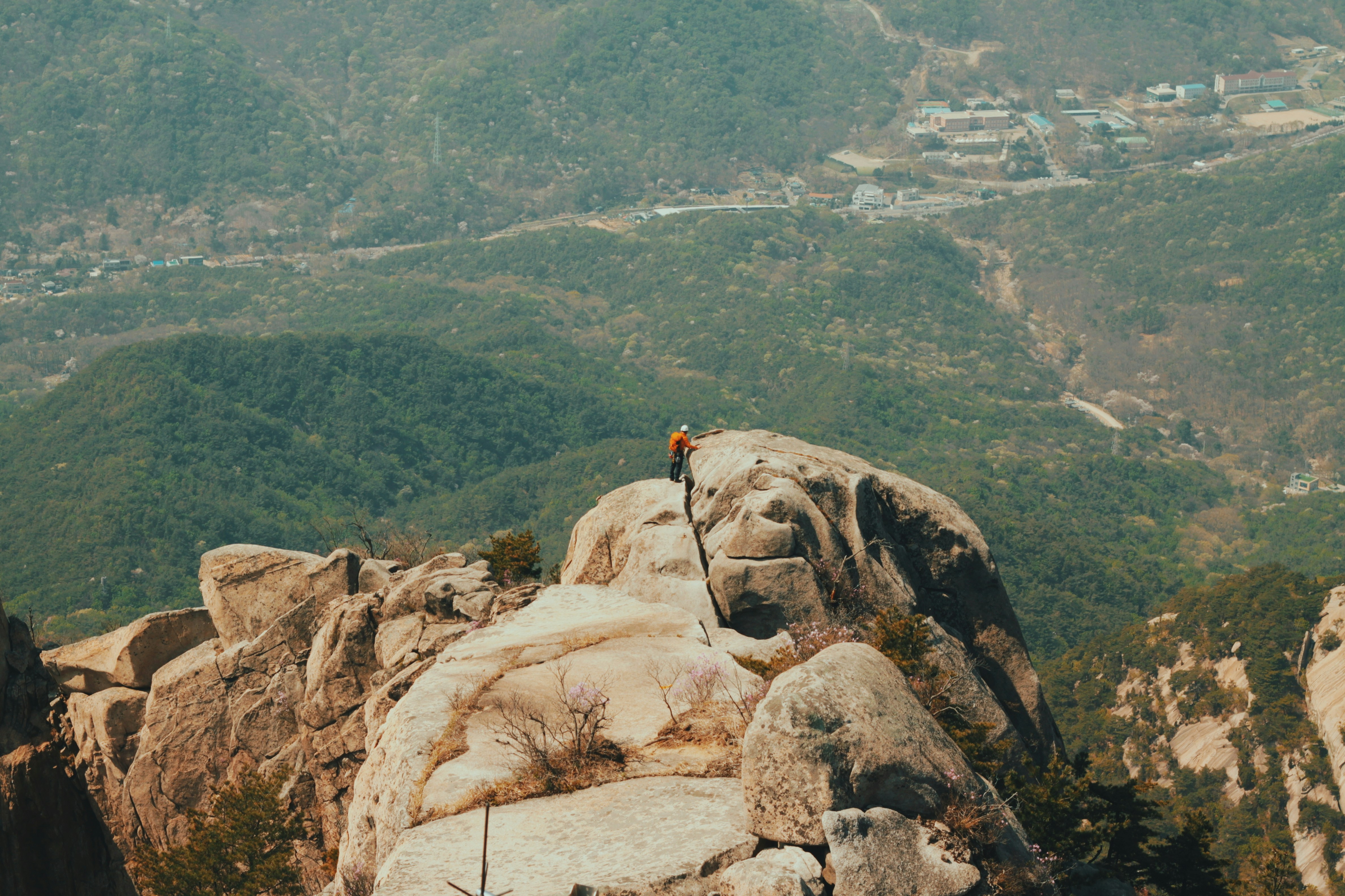 Cliffbound Ascent: A lone climber on sunlit granite