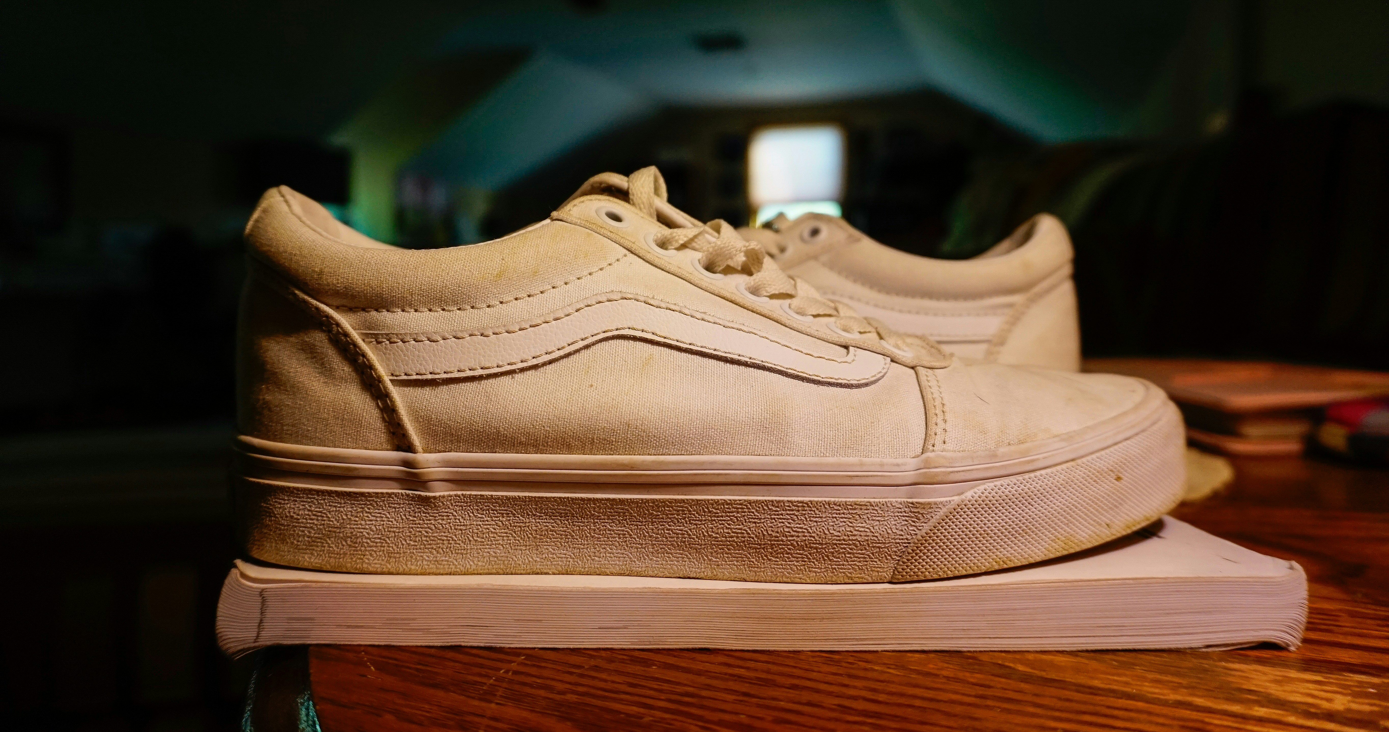 Low-Angle Glow: A Dual-Shoe Spotlight on a Quiet Desk