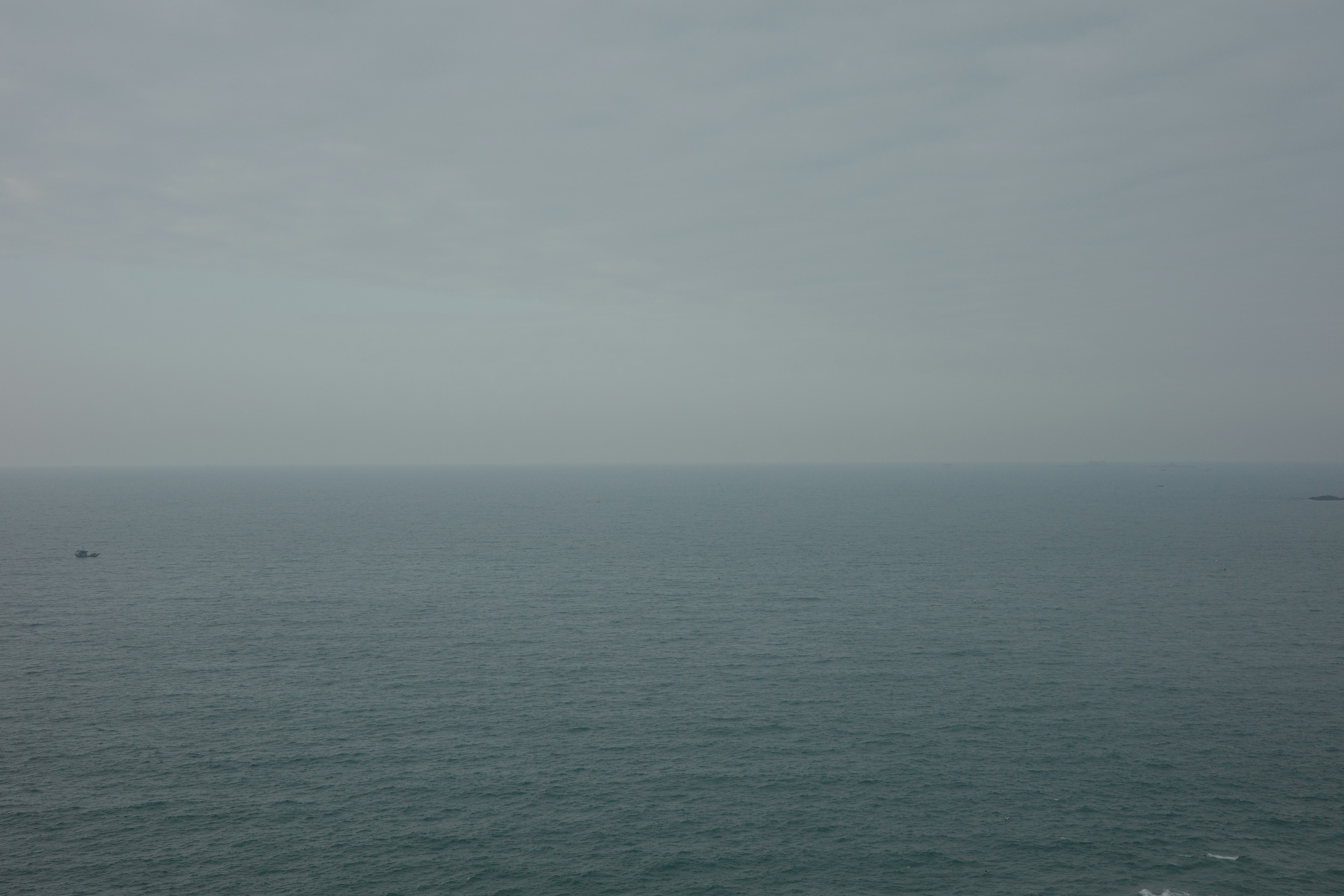Calm ocean water under a hazy sky photo – Free Minimalist wallpaper ...
