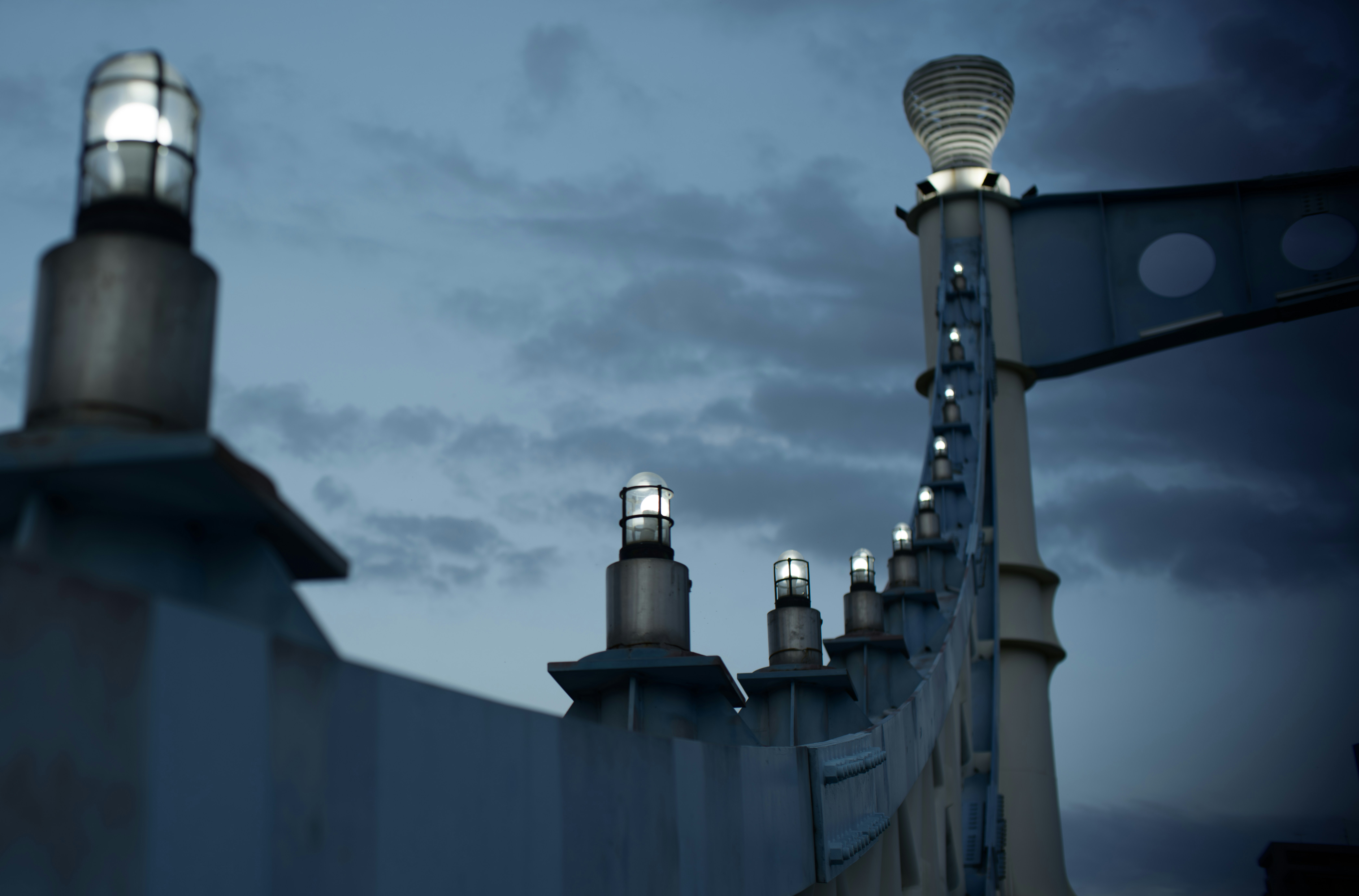 Dockside Beacon: A Quiet Fracture of Light on a Blue Hour Bridge