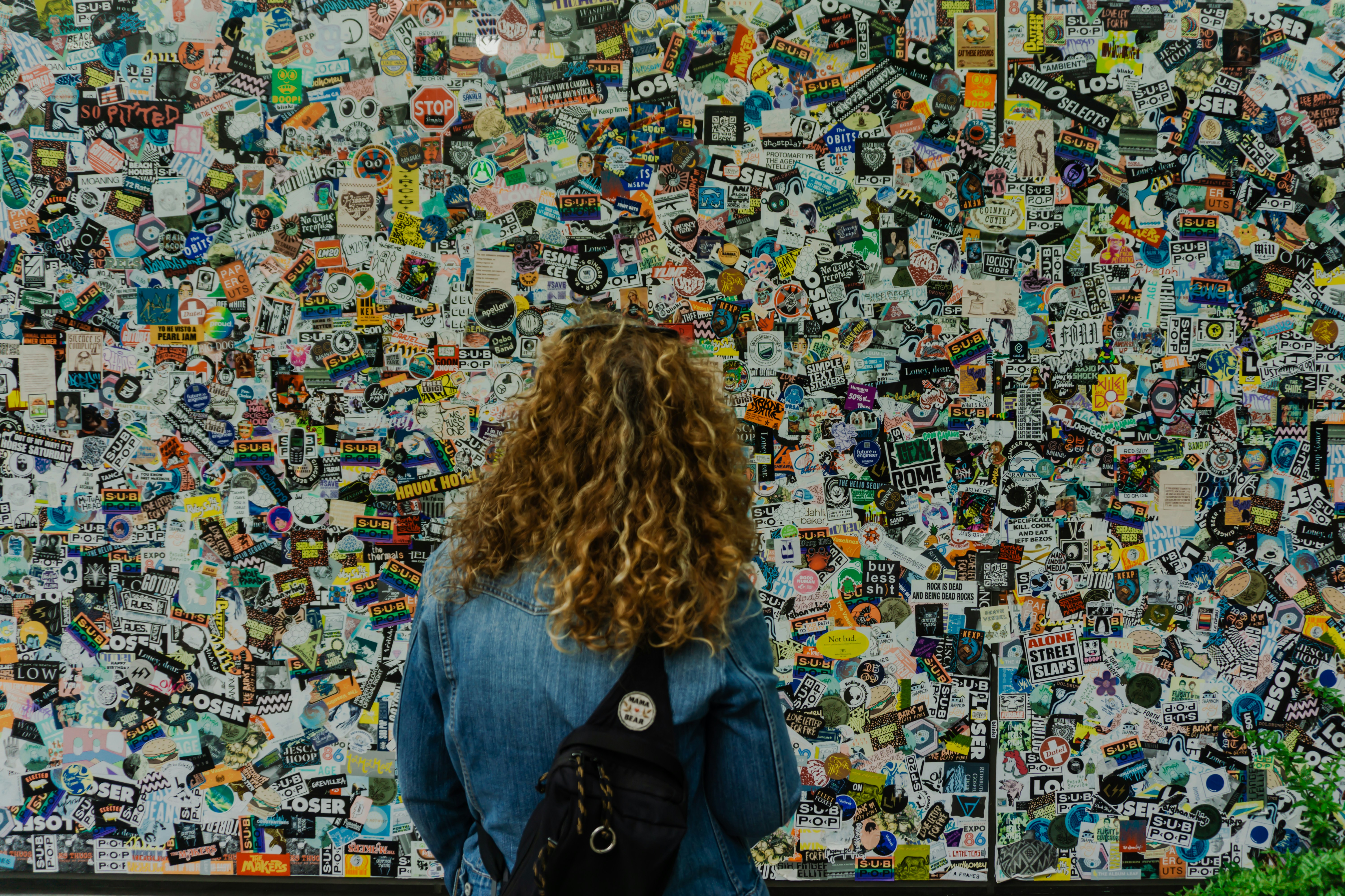 Crowd of stickers meets a denim-clad observer