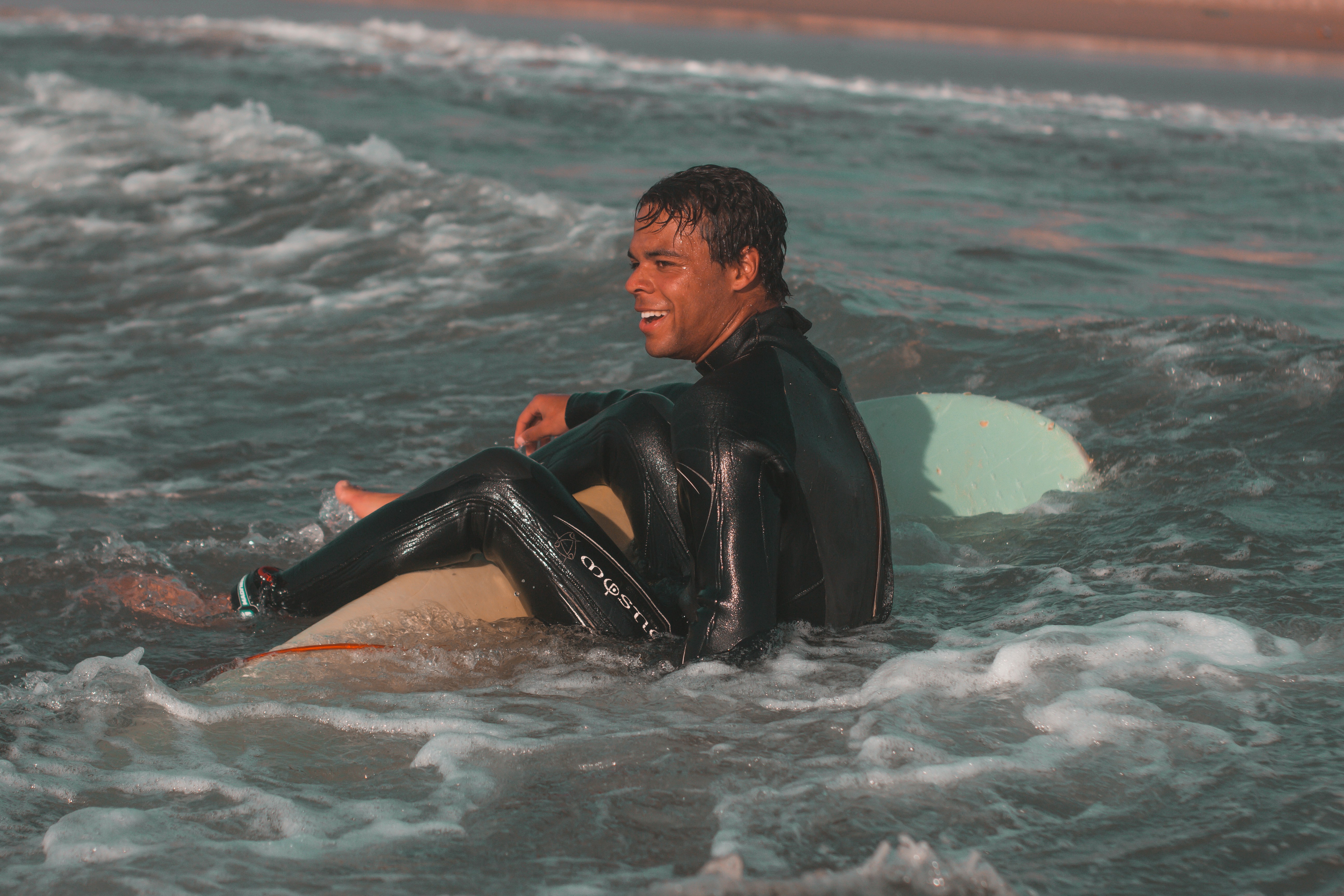 Sunlit Surfer Carves a Quiet Crest on Warm Pacific Swell