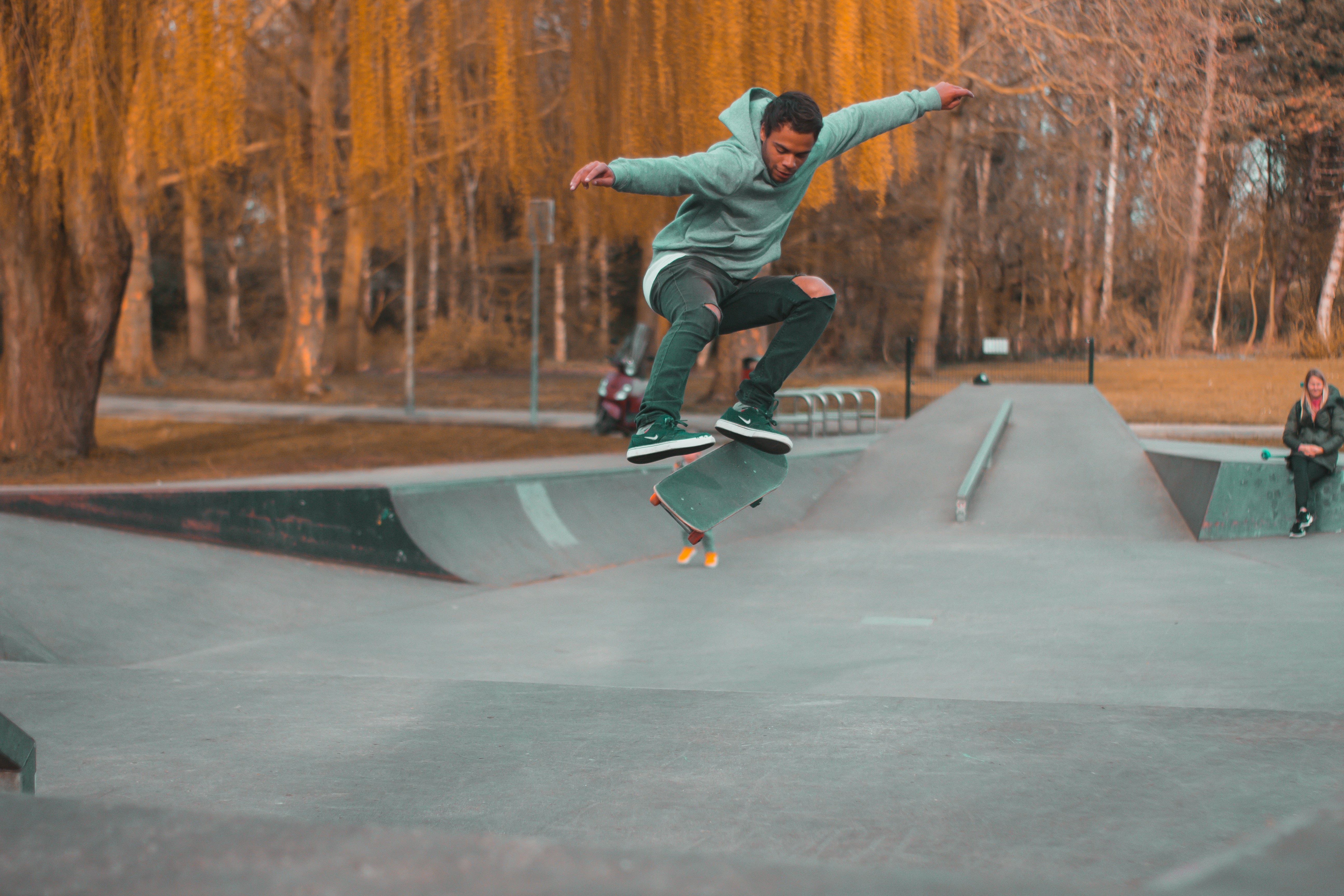 Midair Glide: Skateboarder Flips Over a Concrete Ramp