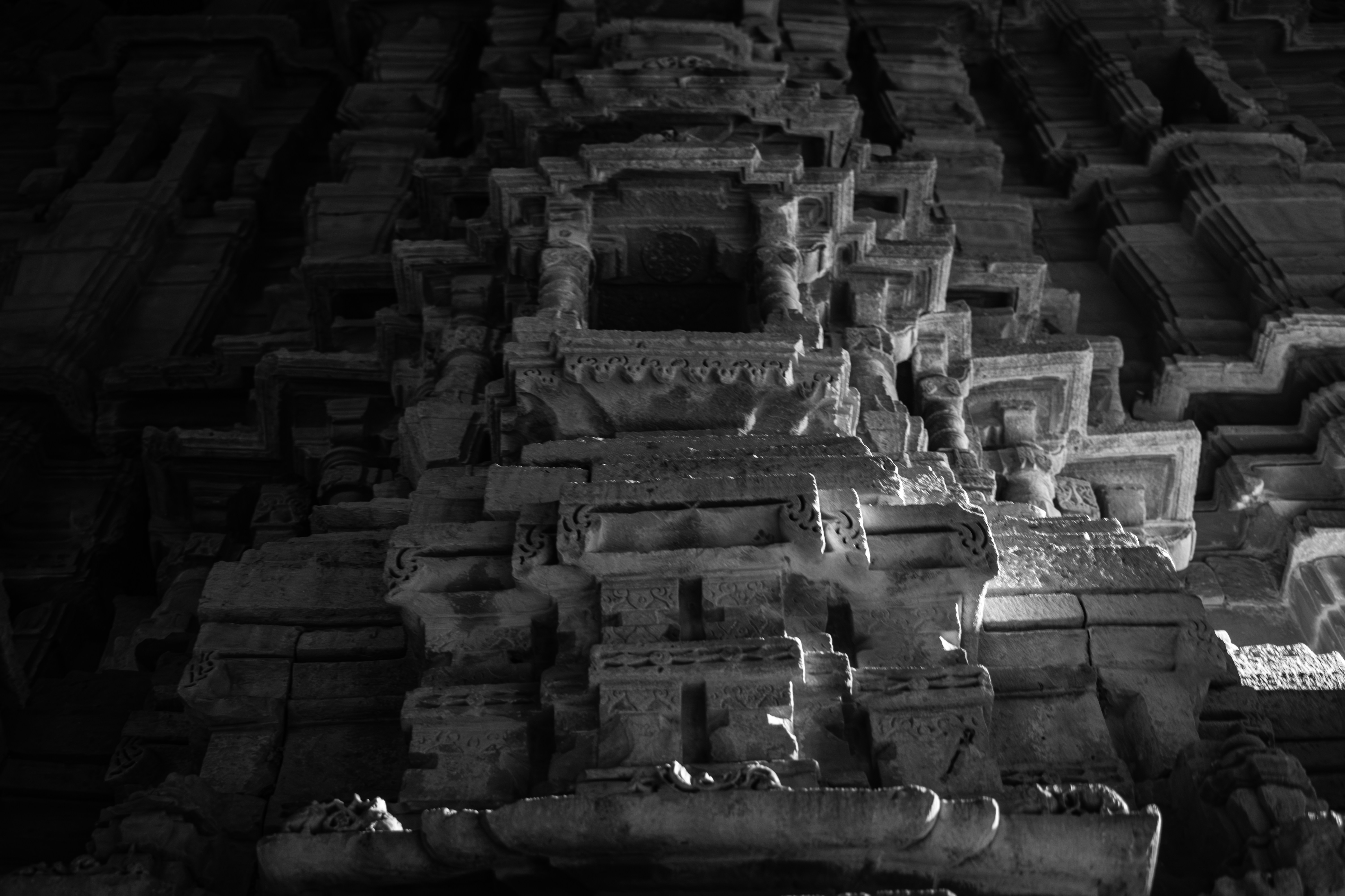 Shadowed Carvings: An Ode to Angled Stone in Monochrome Architecture