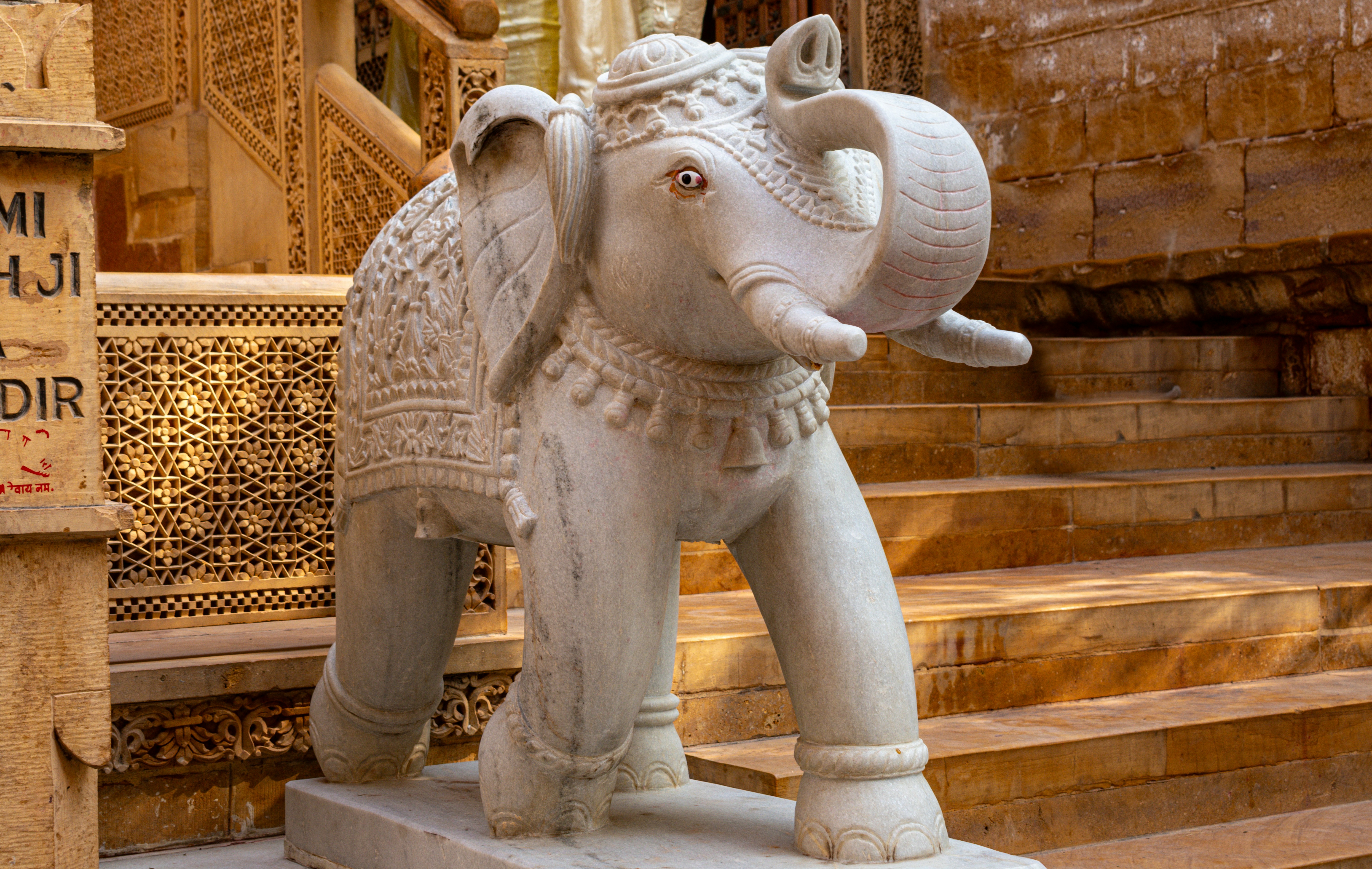 Carved Ivory Guardian: Elephant Statue at the Temple Steps