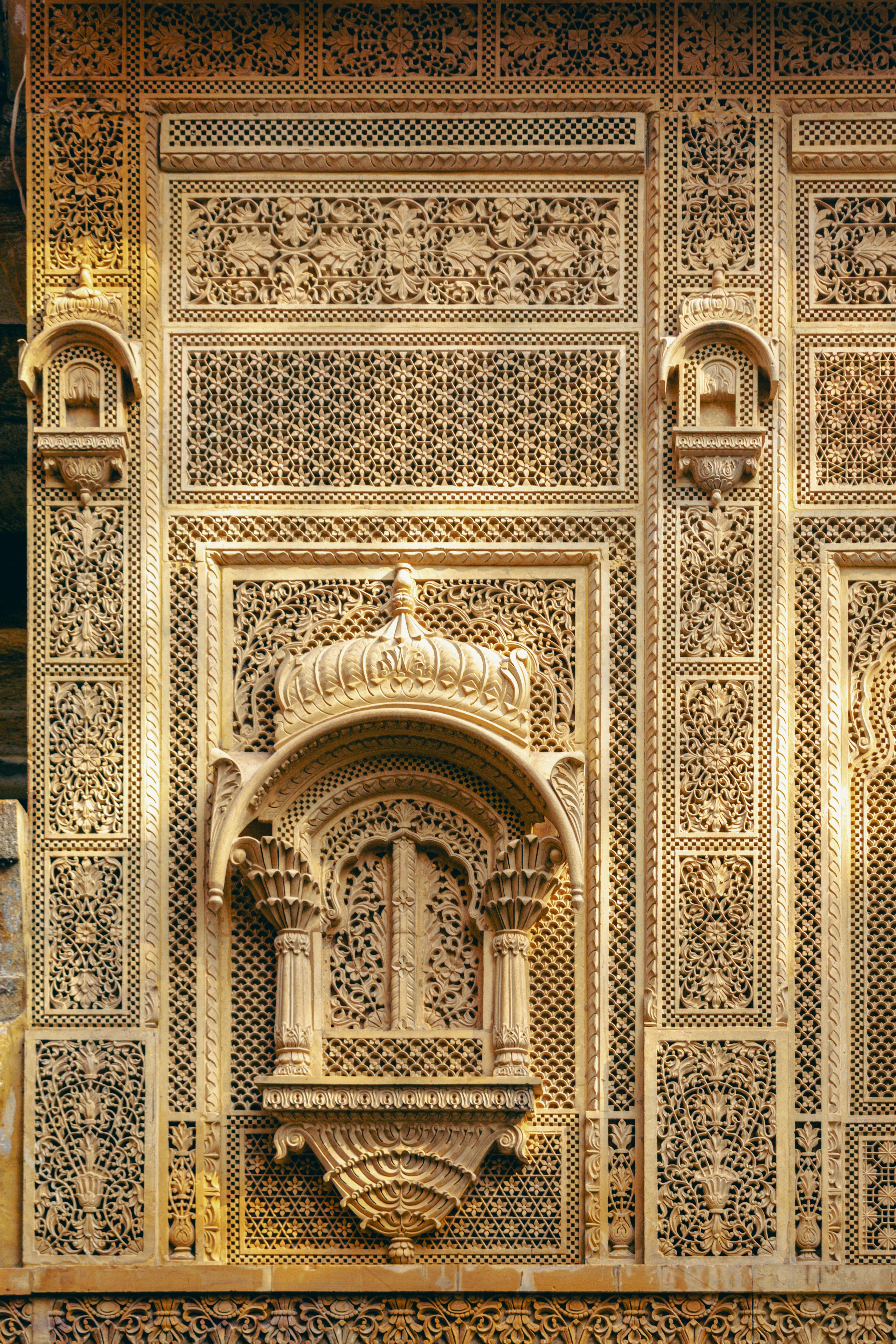 Intricate Carved Facade: A Golden Flush of Moorish Ornament