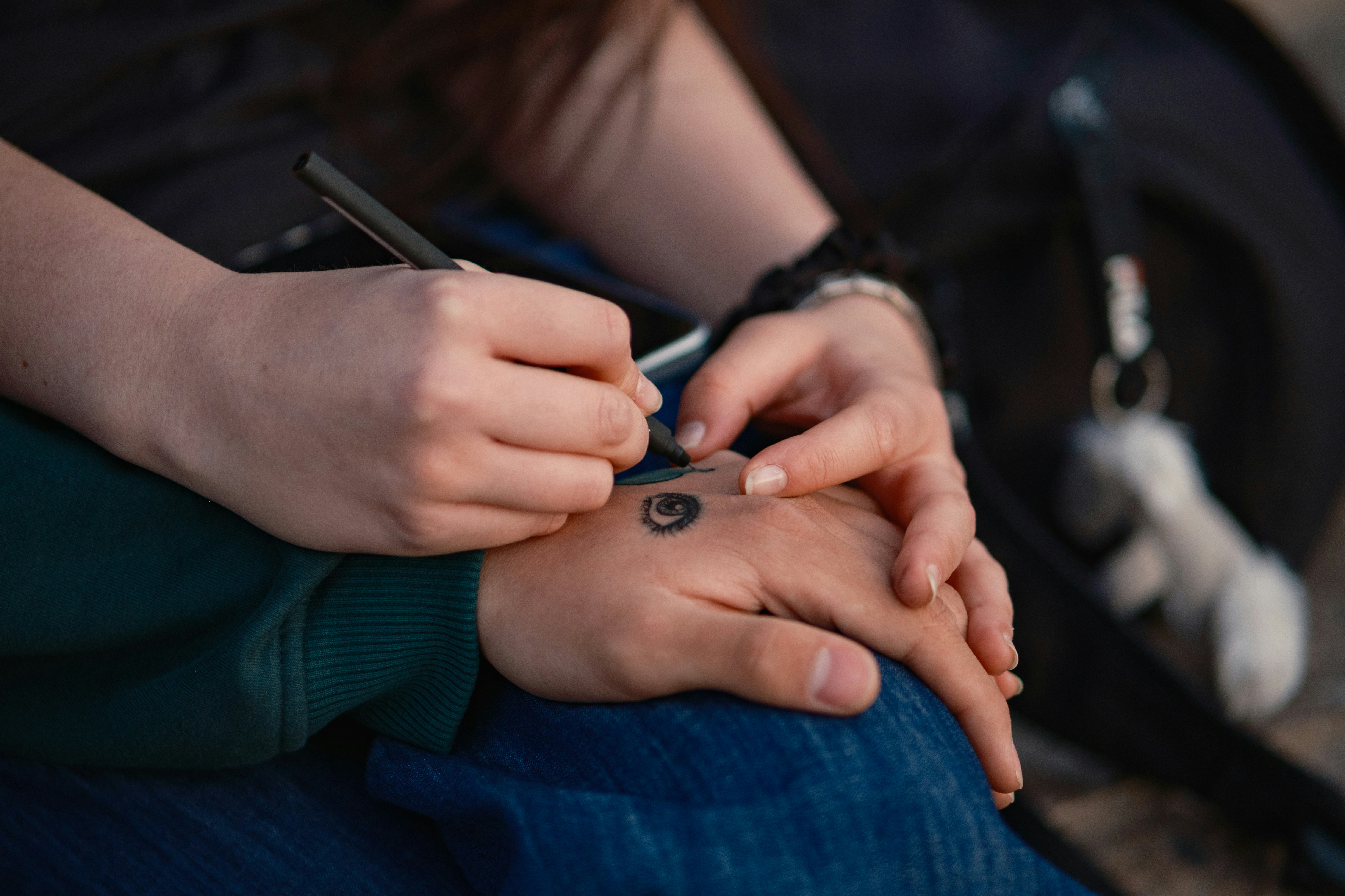 Ink on Skin: A Tiny Eye Emerges Under Crafty Hands