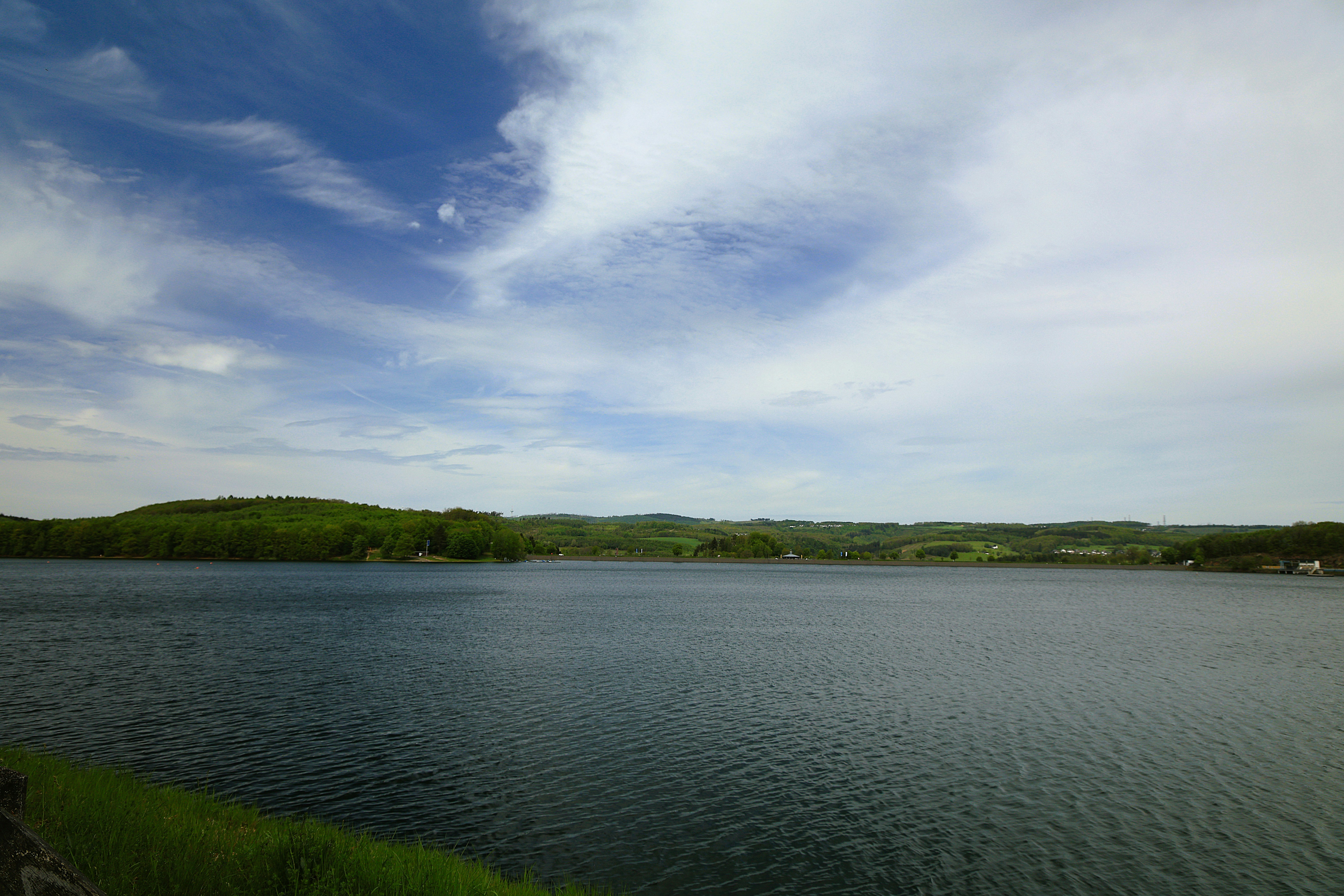 Calm Lakeside Horizon Under Blue-Sky Sweep