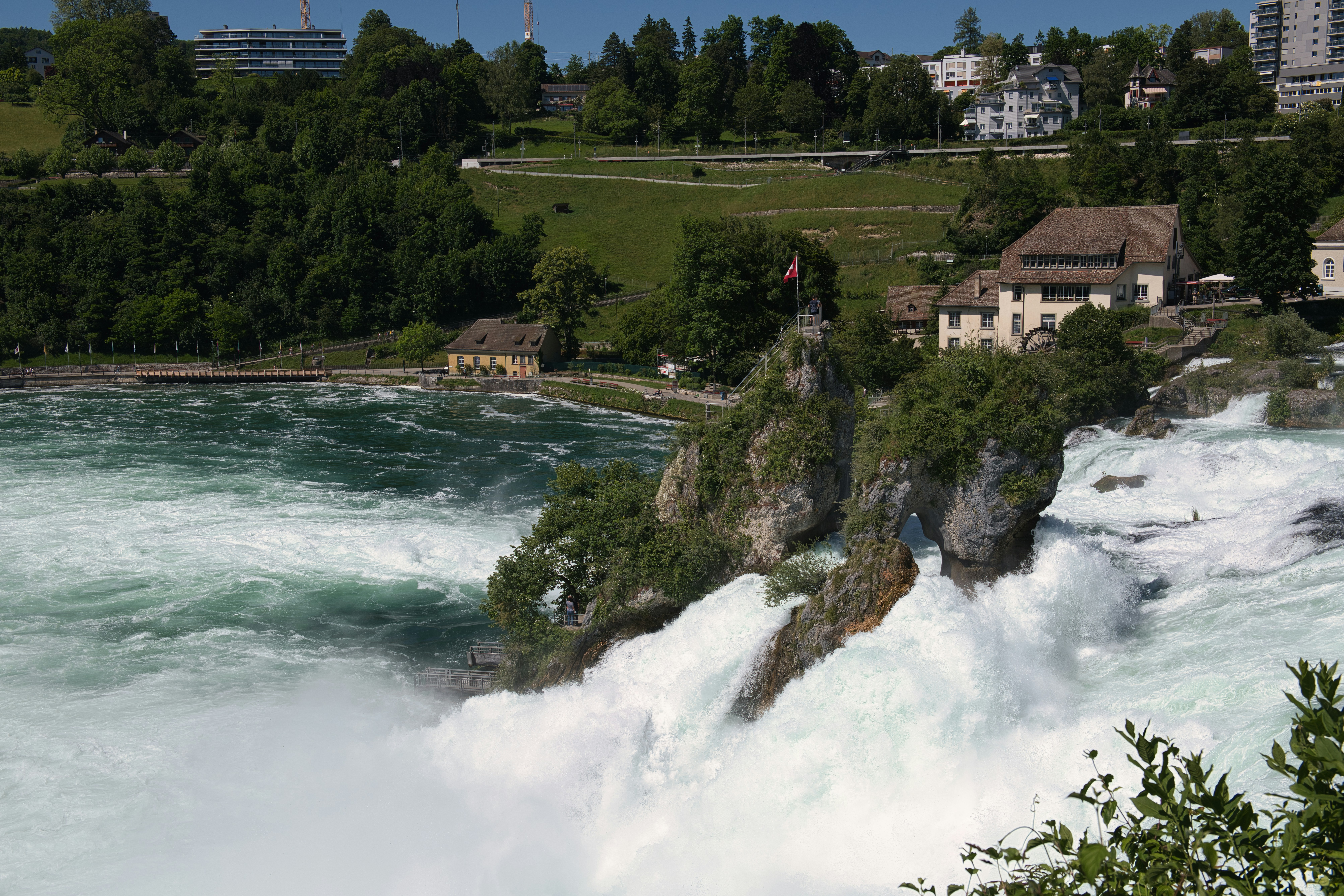 Rushing Water Meets Quiet Cliffs: A Swiss Rapids View