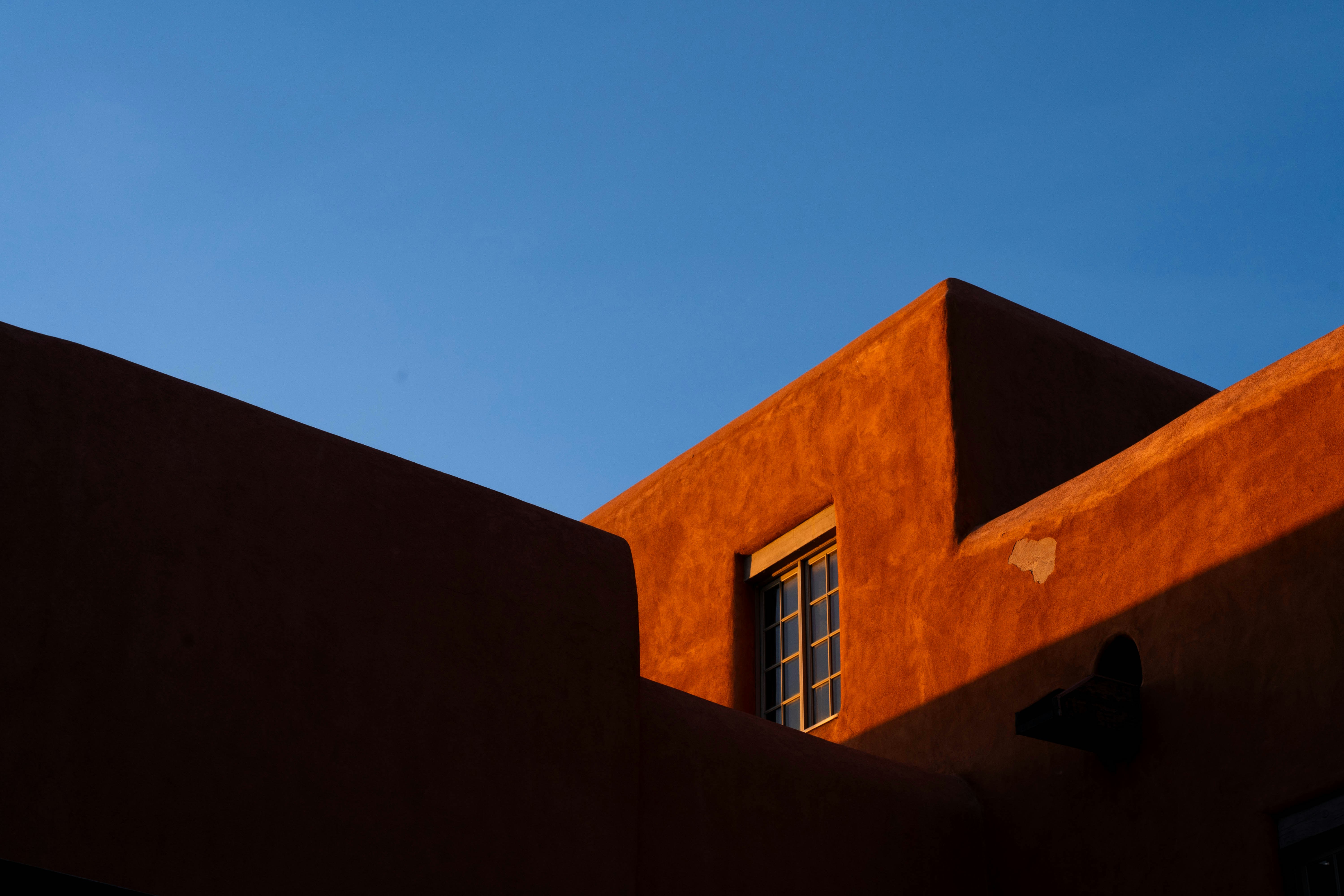 Sunlit Terracotta Geometry Against a Clear Sky