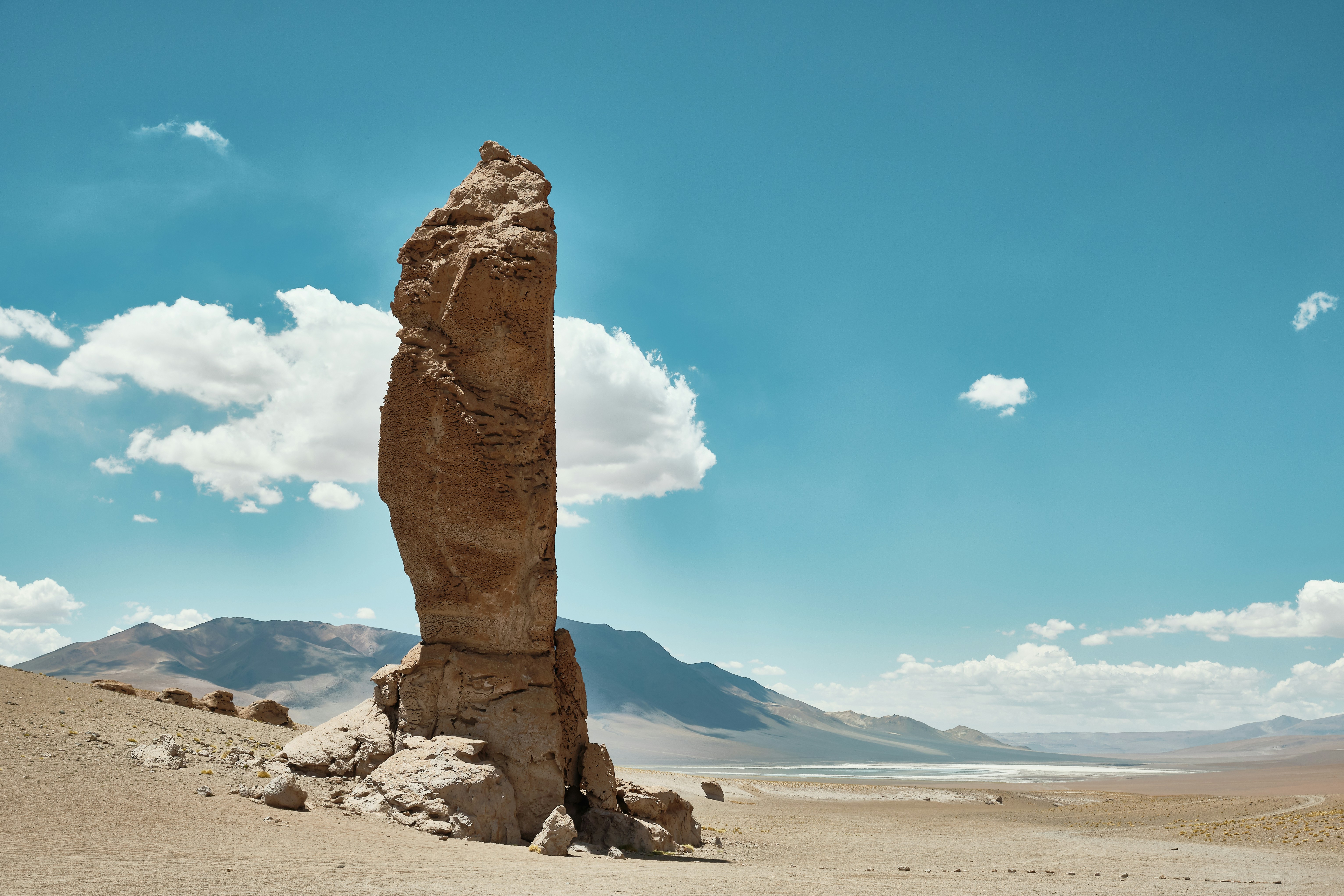 Desert Monument: A Singular Pillar Rising from Quiet Sand