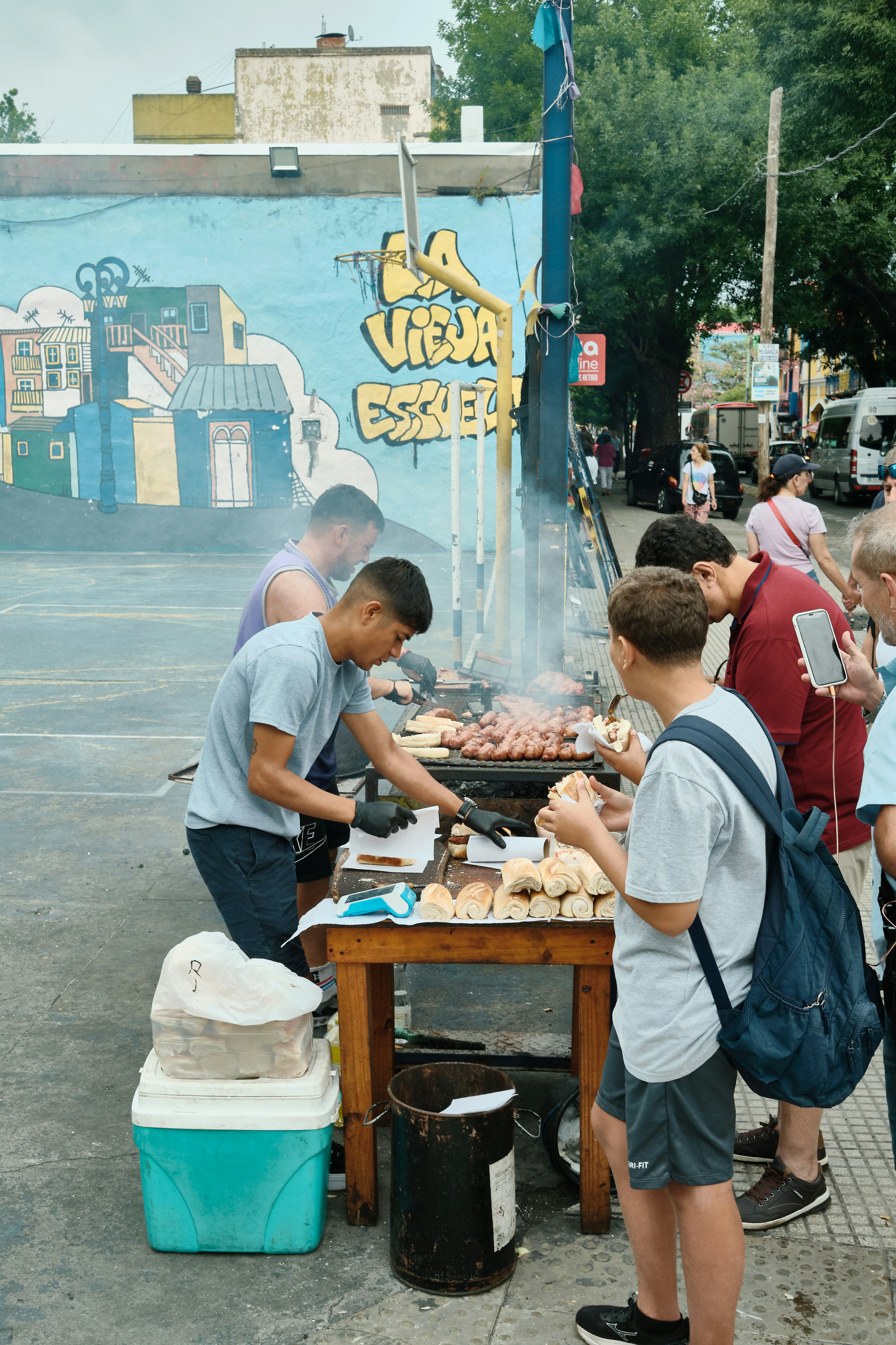 Grilling the Street: A Crowd Gathers Around a Busy Barbecue Stand