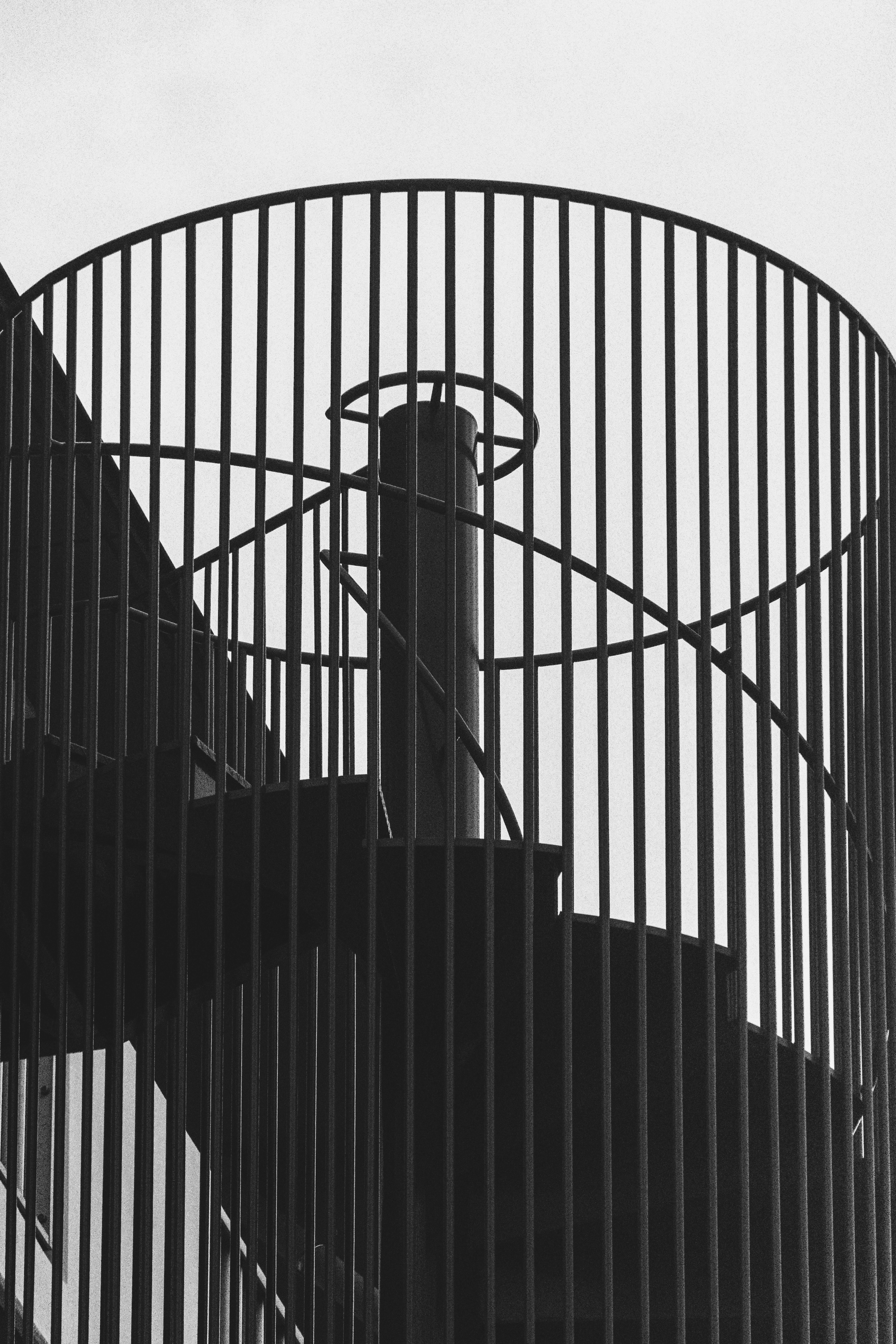 Vertical Bars and Spiral Guard: A Staircase Encased in Metal Rings