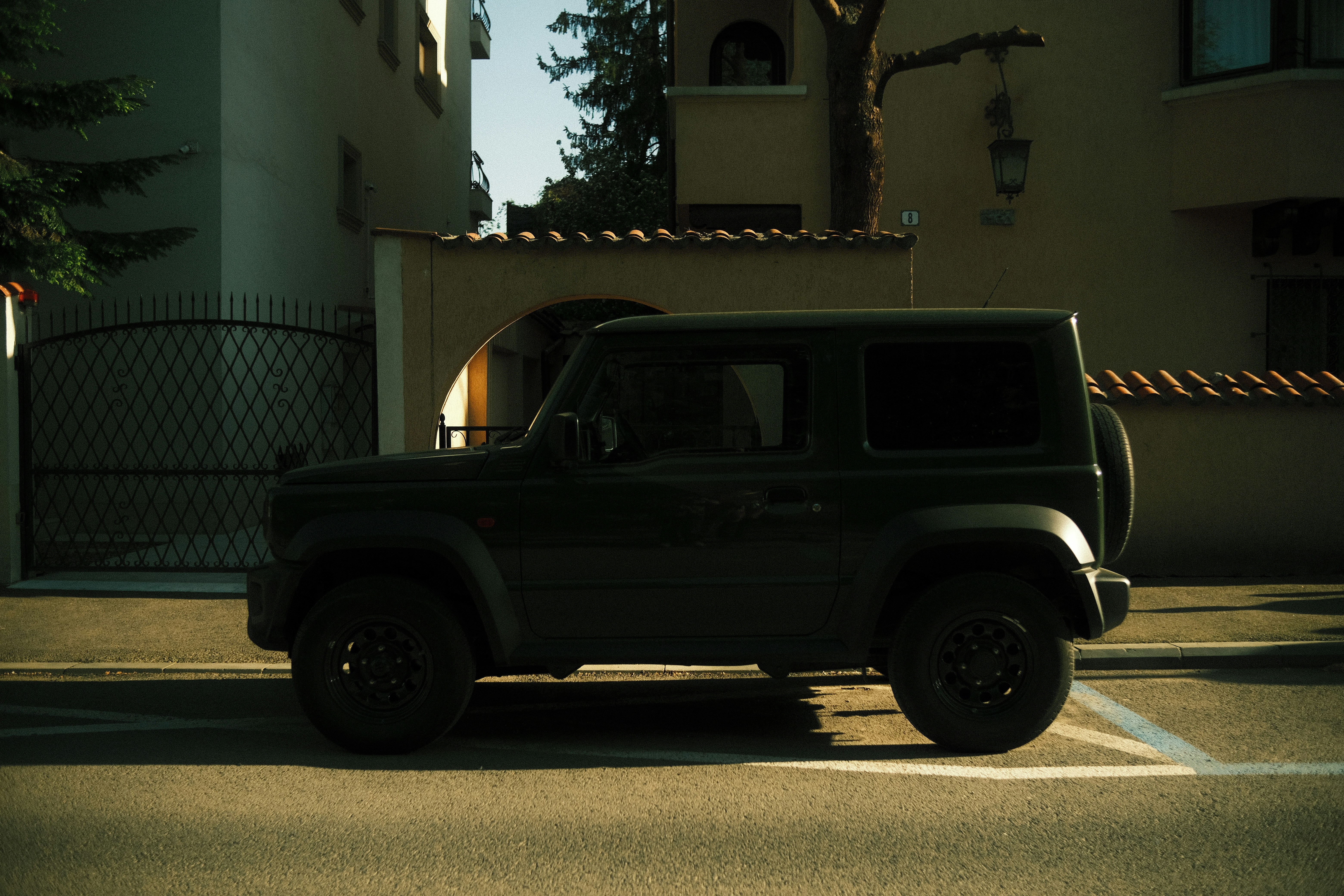 Shadowed SUV in a Quiet Courtyard