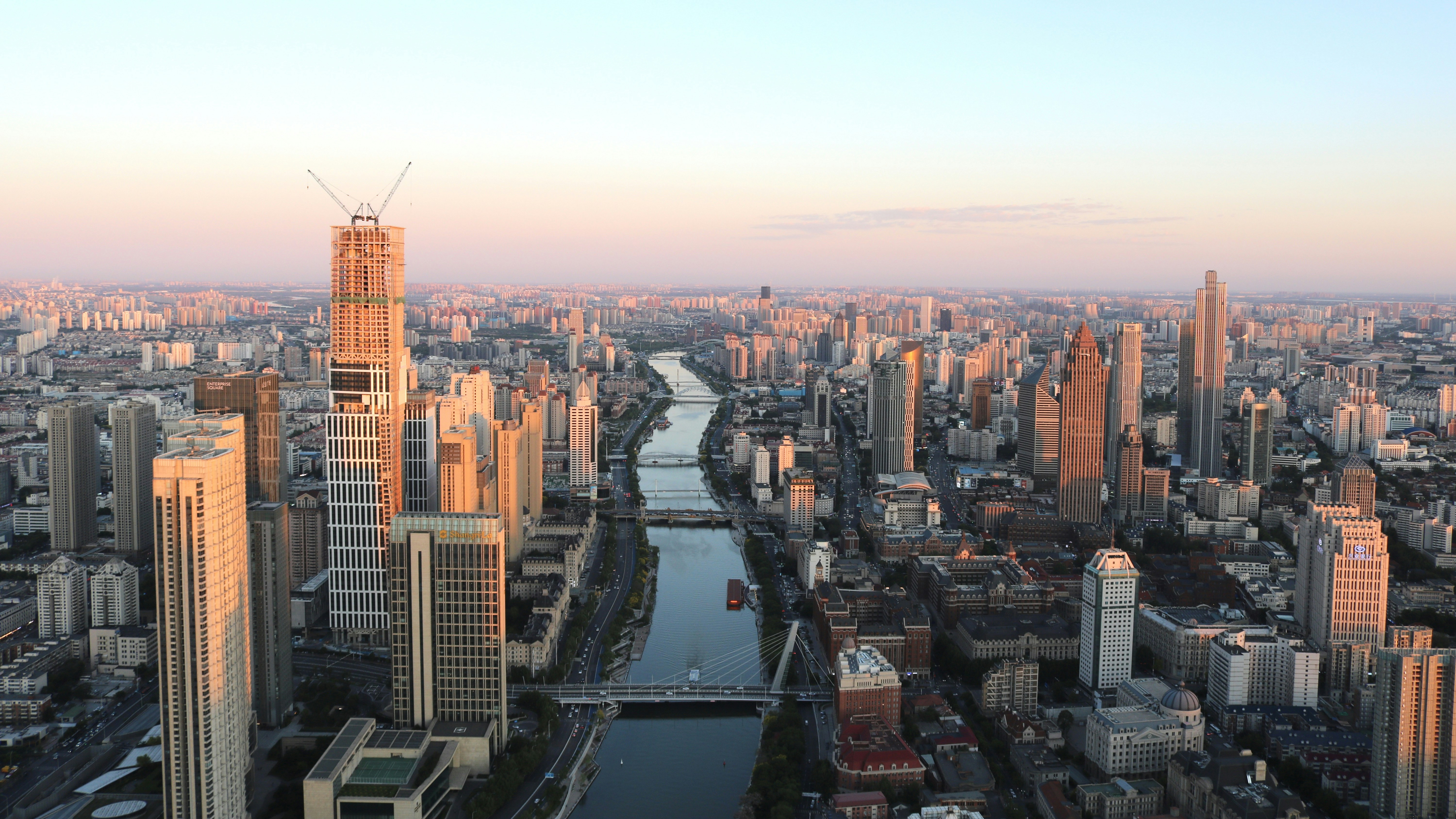 Rising Confluence: A Sedan of Skyscrapers Tracing a Winding River
