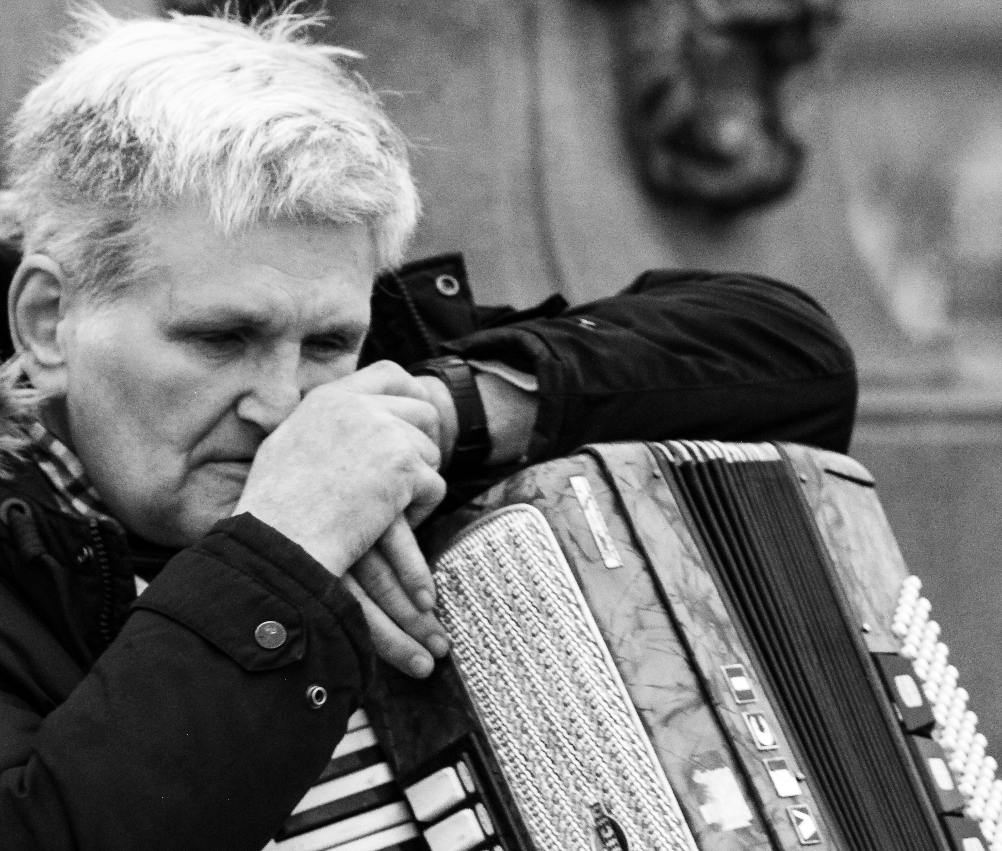 Close-up of a musician: focused breath and fingers on the accordion