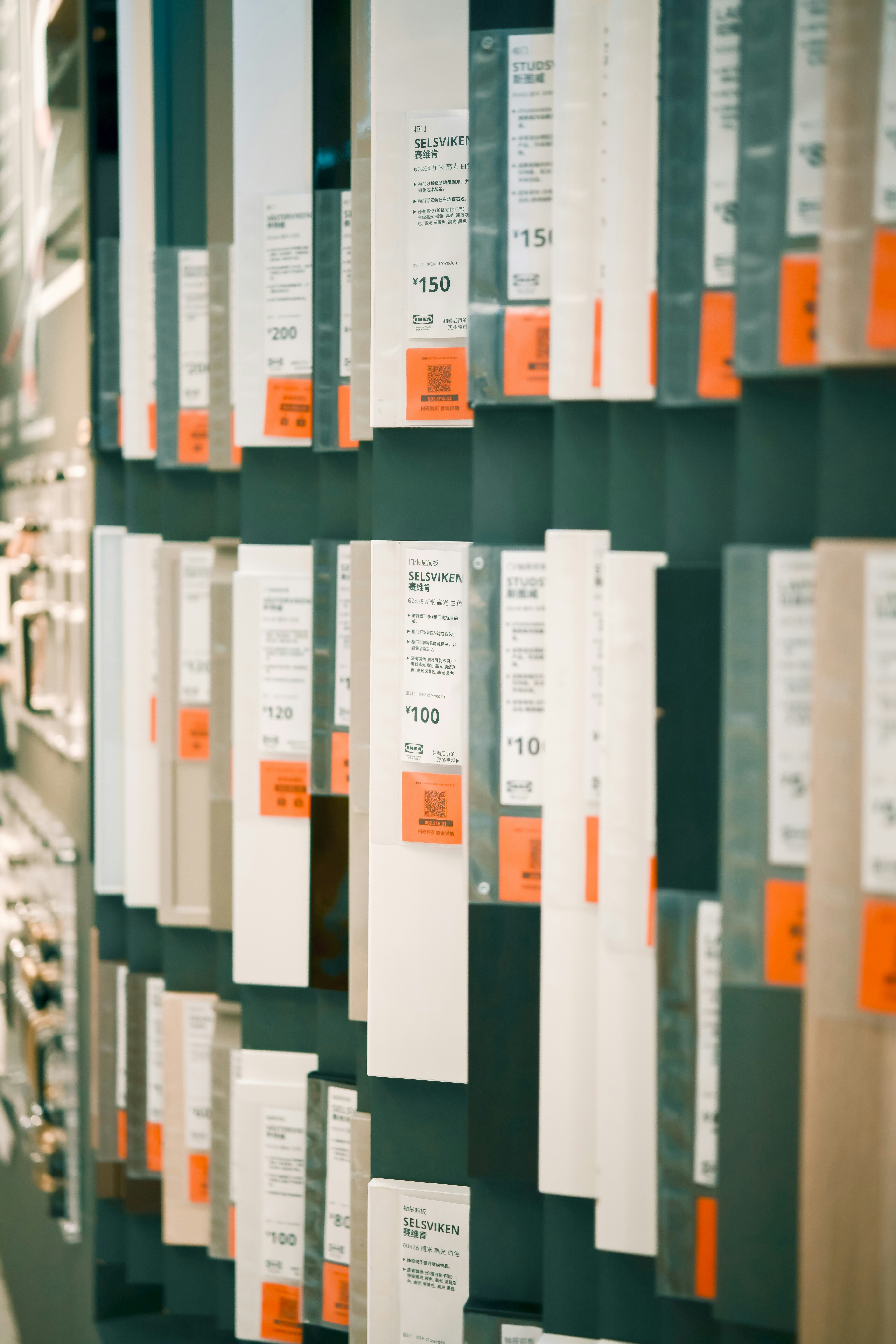 Vertical Library: Neon-Orange Tags on a Wall of Slotted Panels