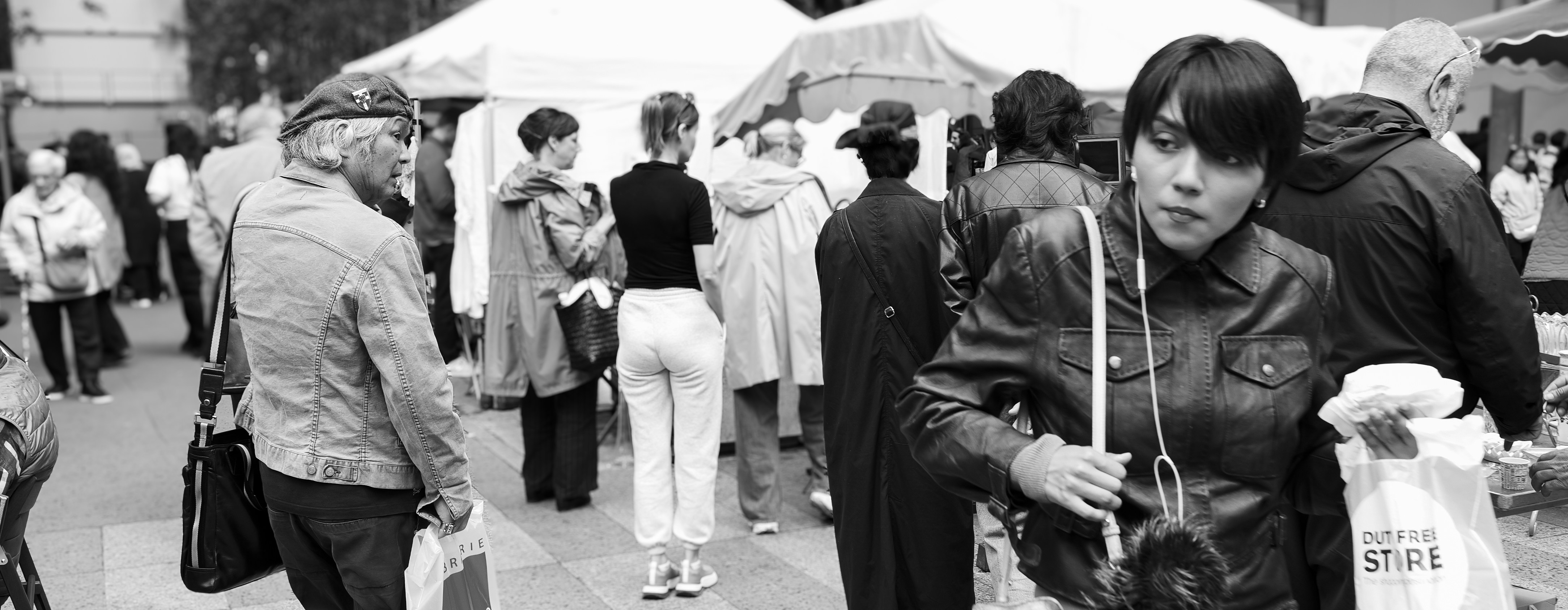 Coexisting Moments: A Quiet Portrait in a Busy Market