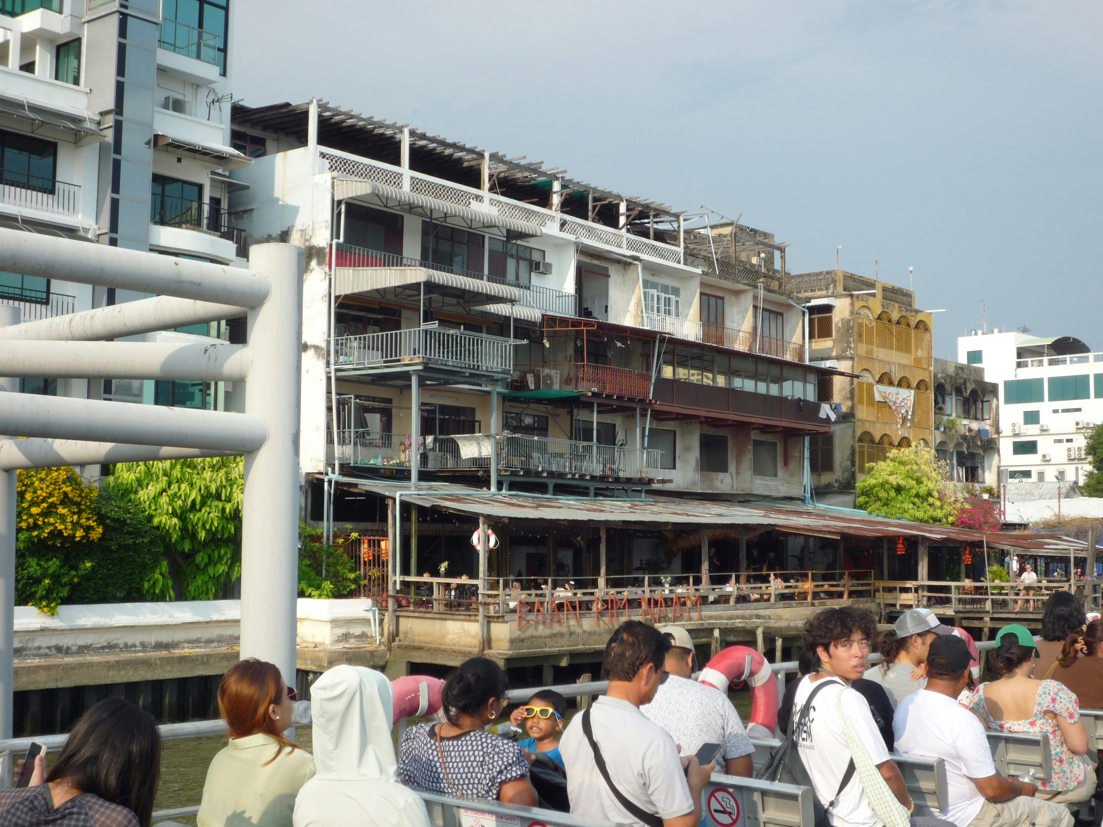Riverside Marketfront: A Tangle of Balconies and People