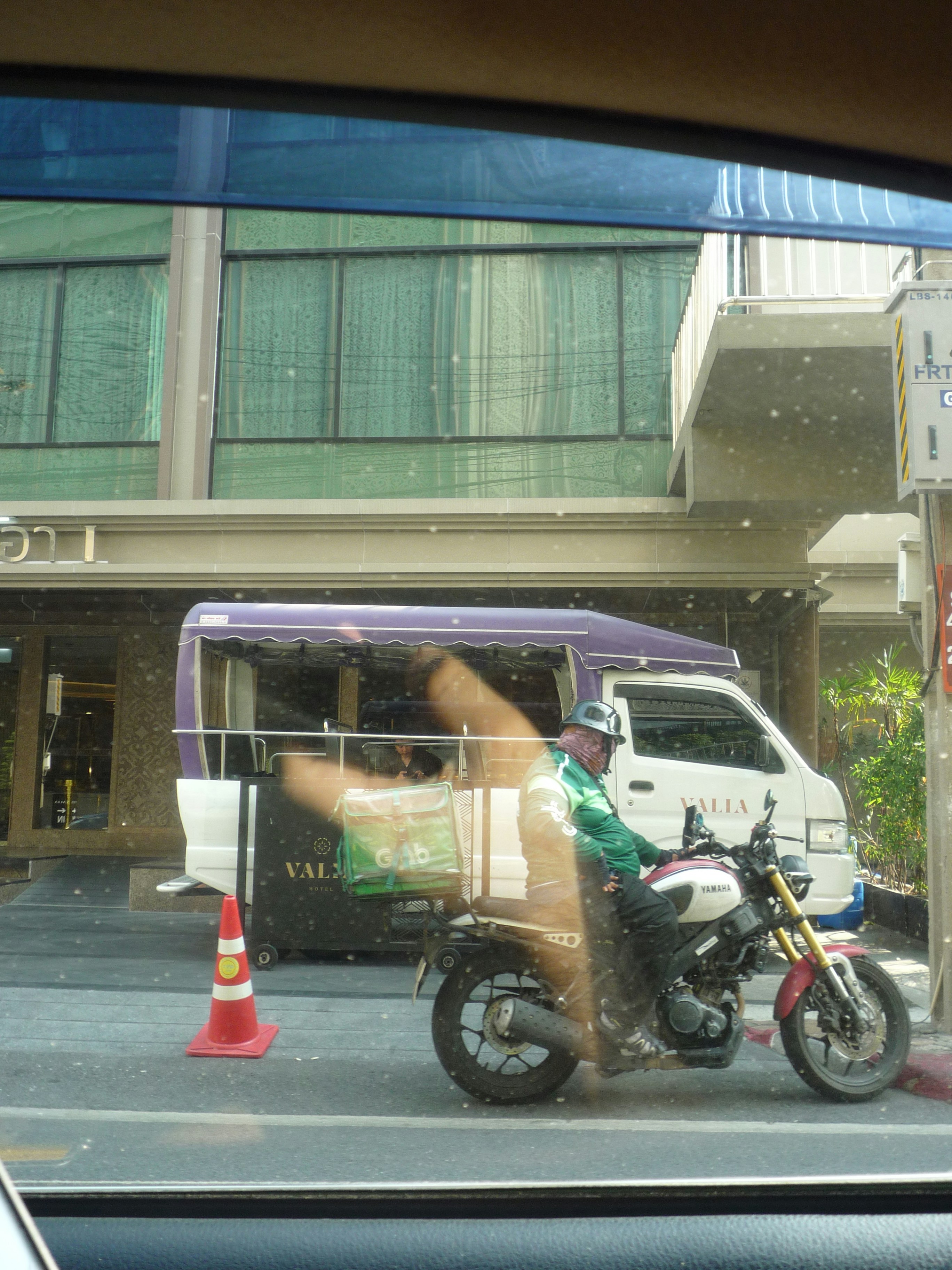 Blurred Rider and Purple Van in Urban Street Scene