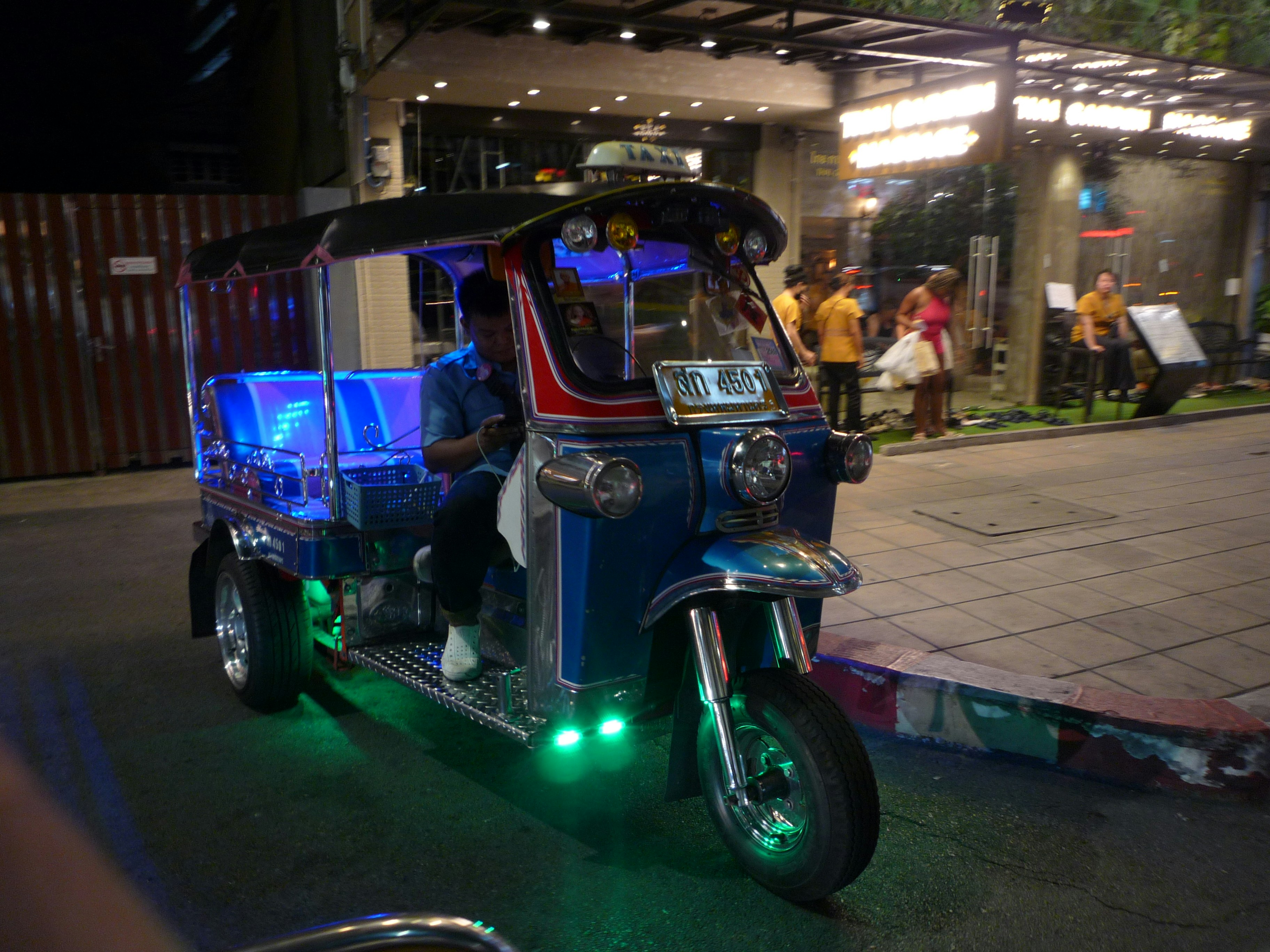 Neon-lit Tuk-Tuk in Evening Street Scene