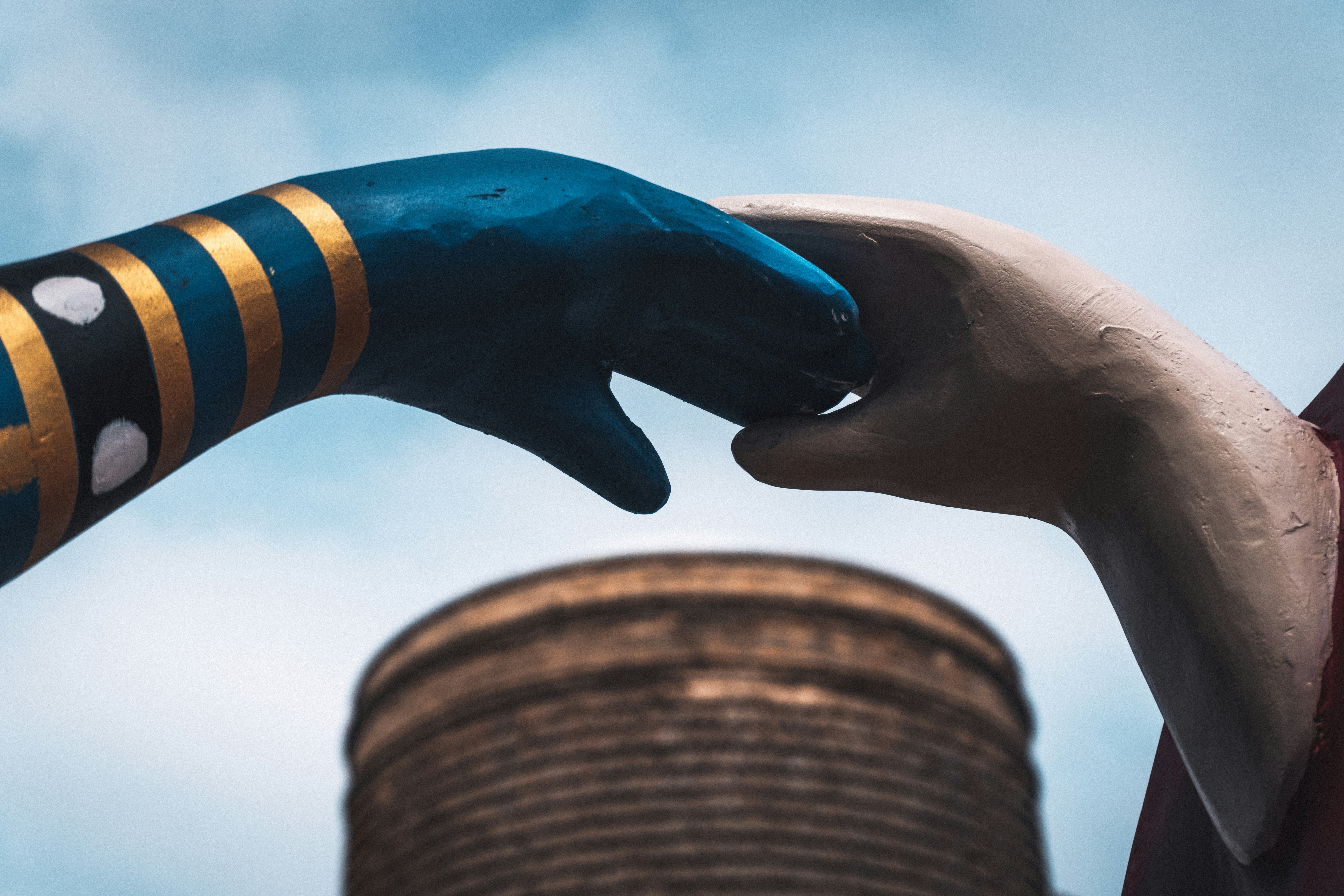 Handshake Across Cultures: Painted Arms Meet Under an Open Sky