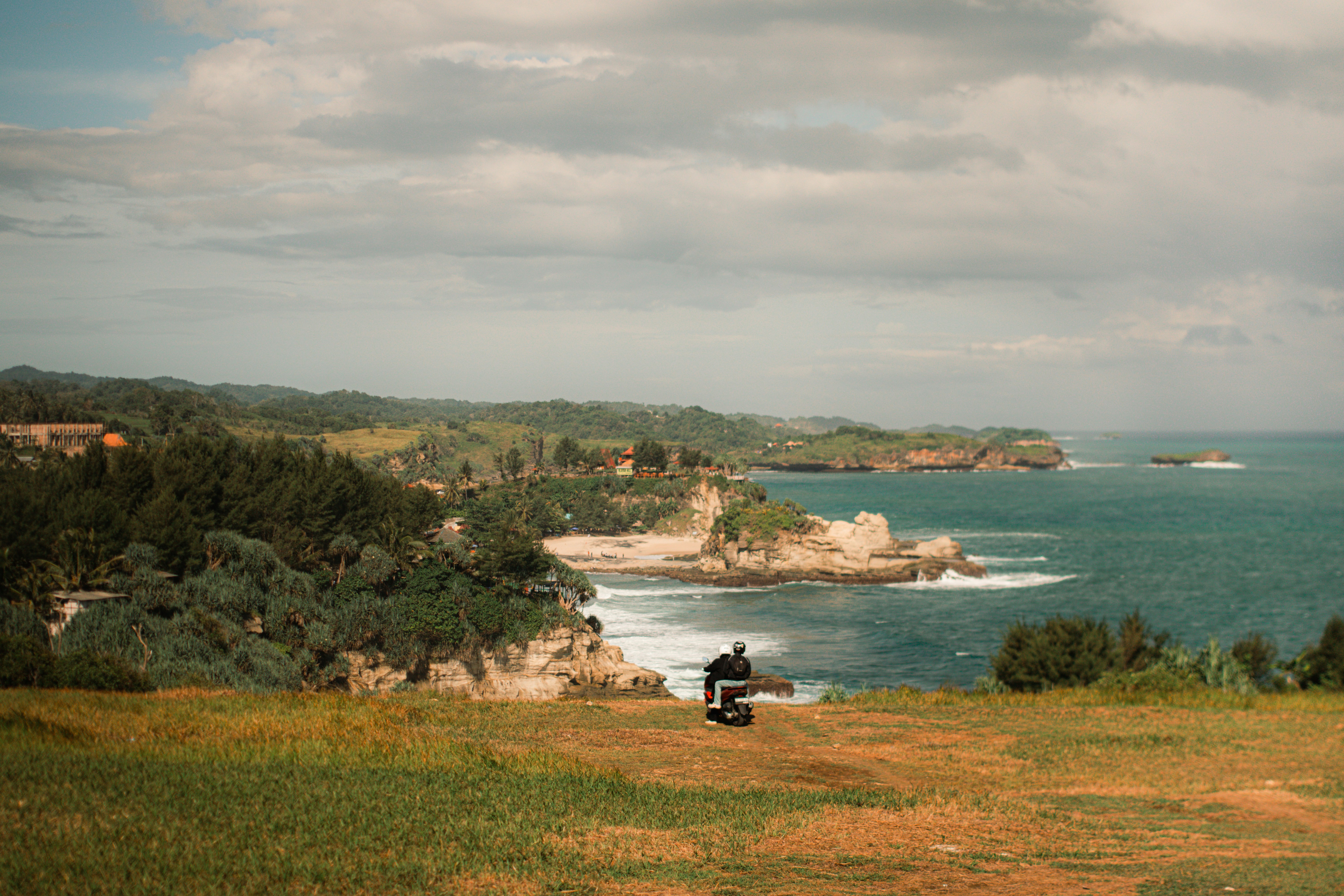Coastal overlook with lone rider tracing the cliff edge