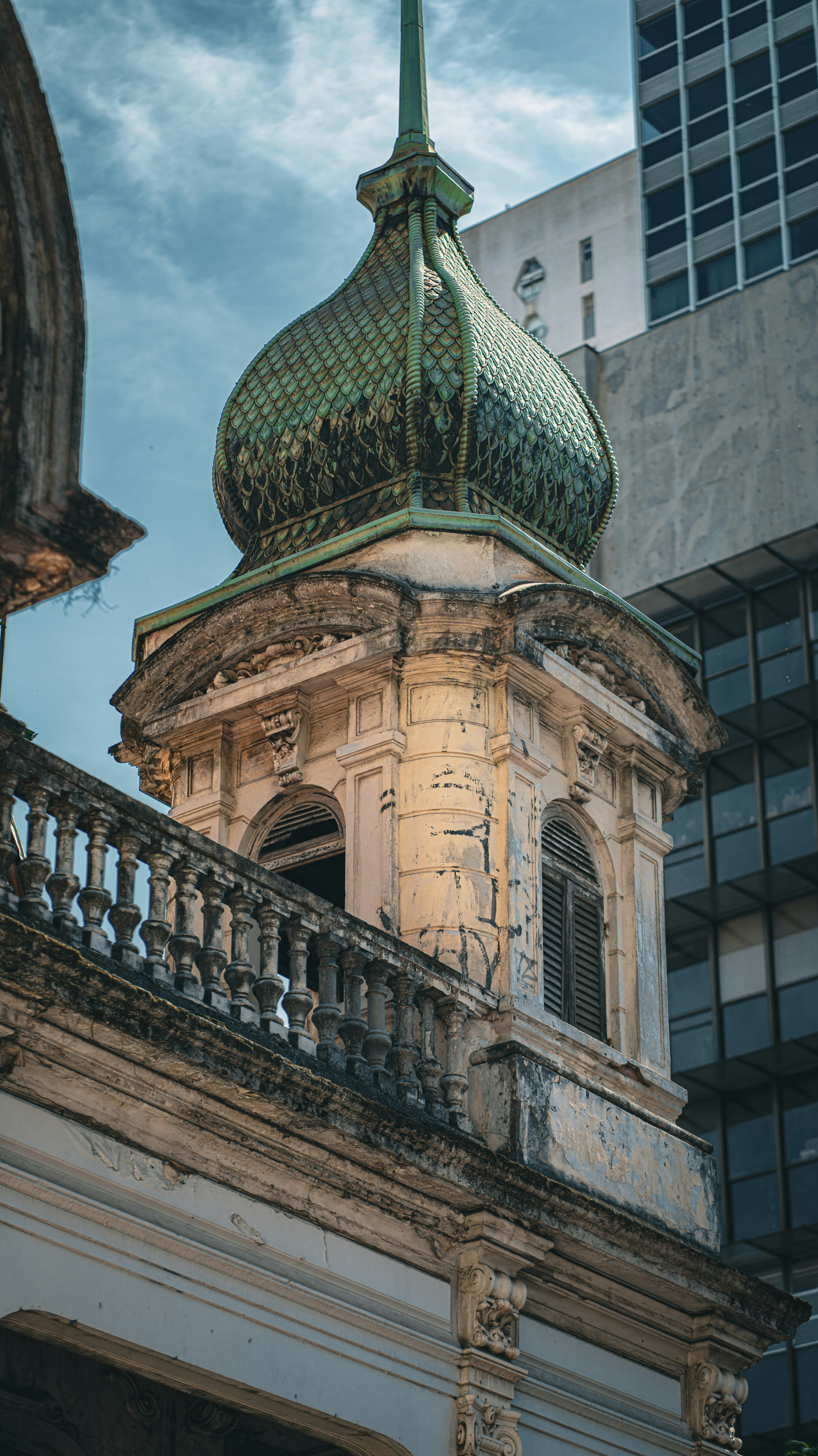 City Rooftop Turret with Emerald Dome Surrounded by Modern Glass