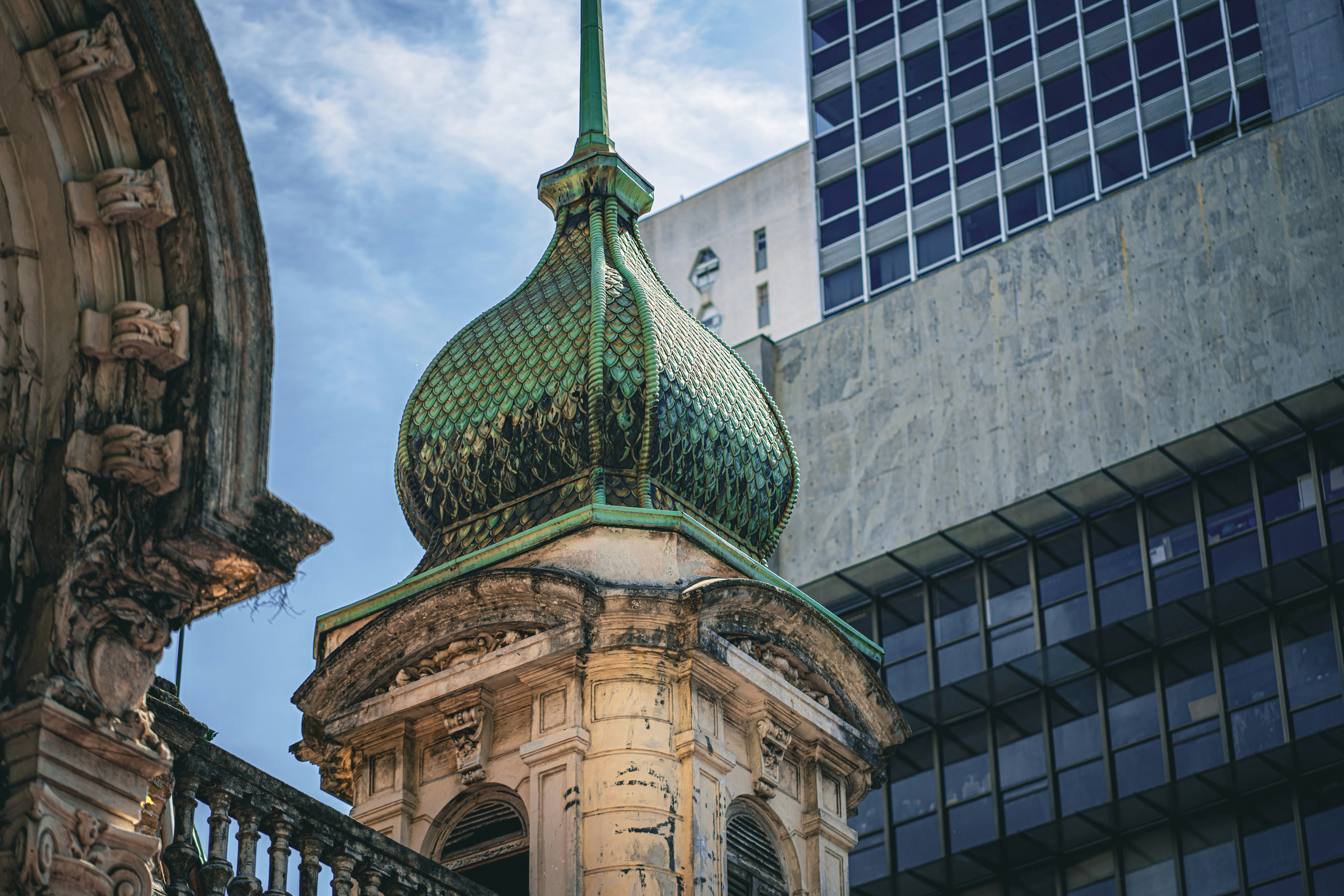 Historic Turret Against Glass: A Clash of Eras