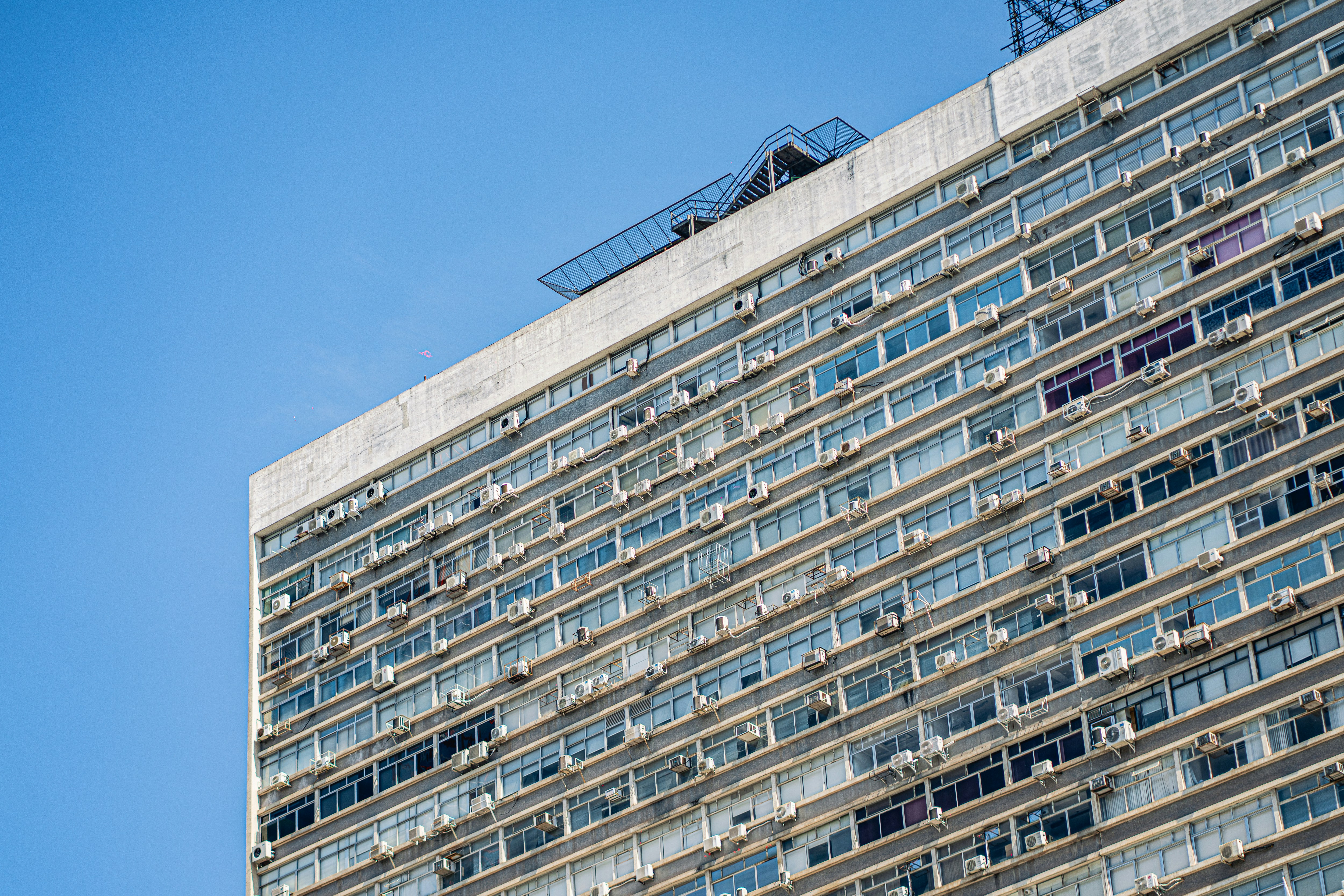 Concrete Gridrise: A Skew of Windows Against a Clear Sky