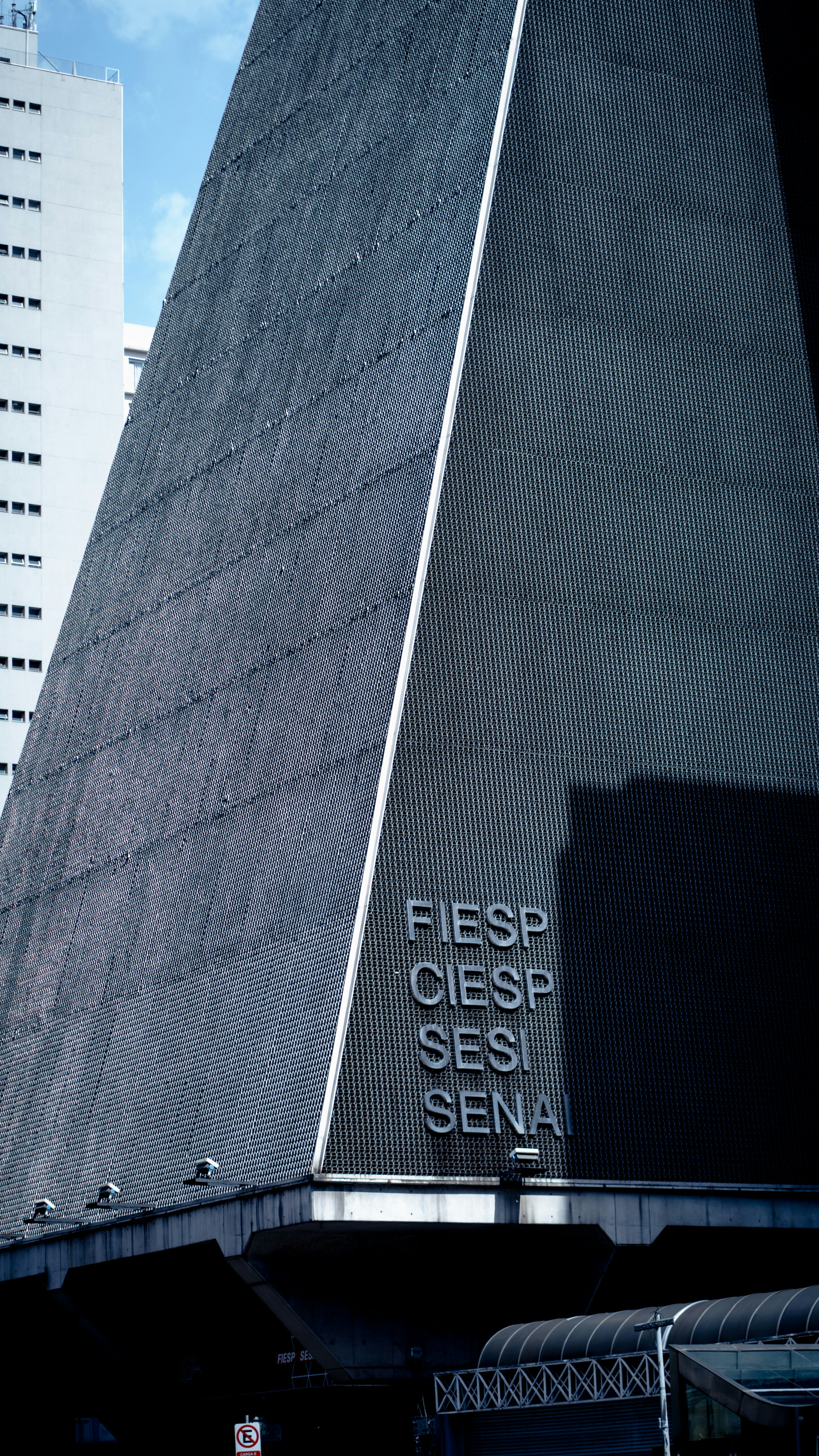 Concrete Facade in Shadow: A Vertical Slant of Modernism