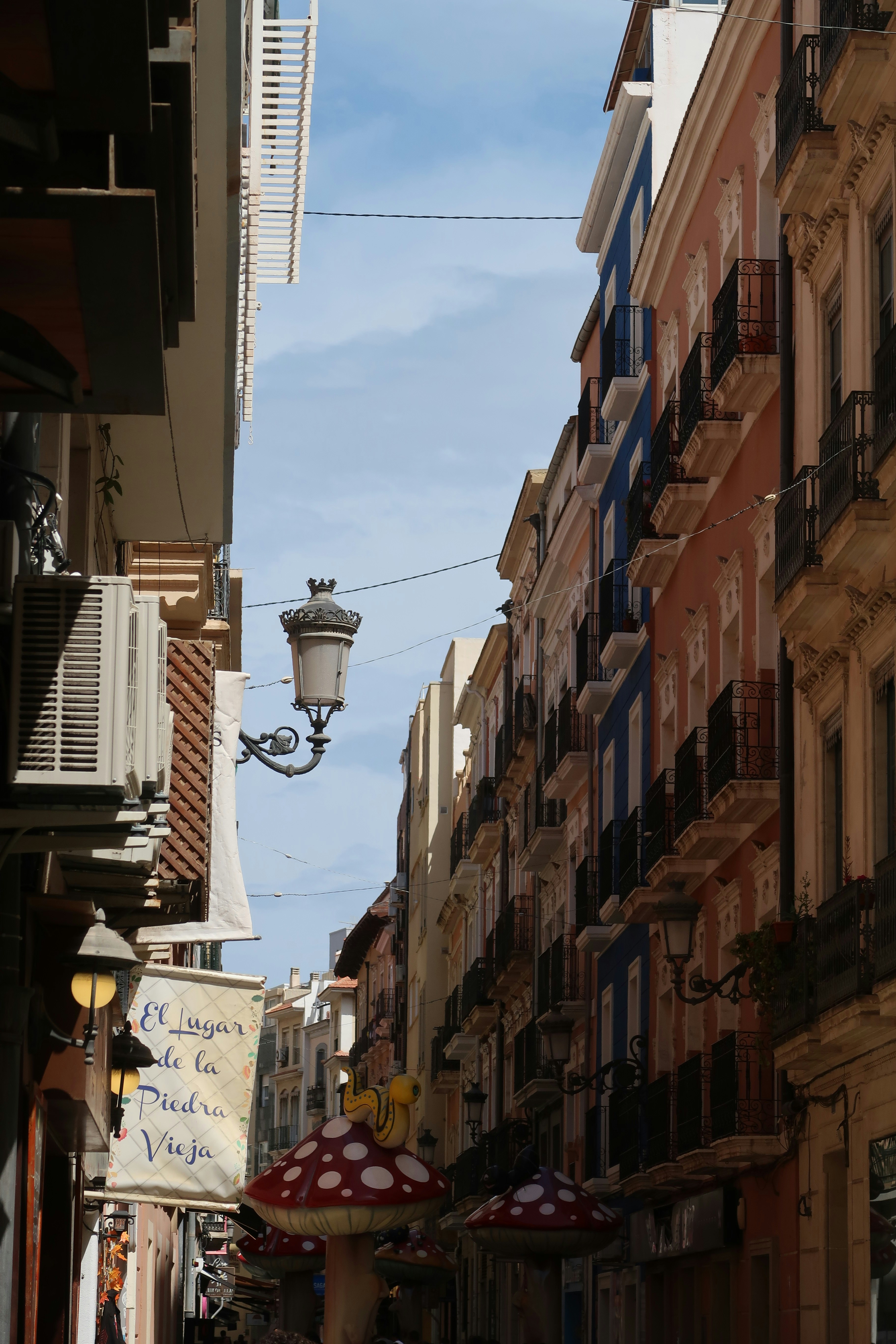 Cobbled Alleyway of Balconies and Street Lamps