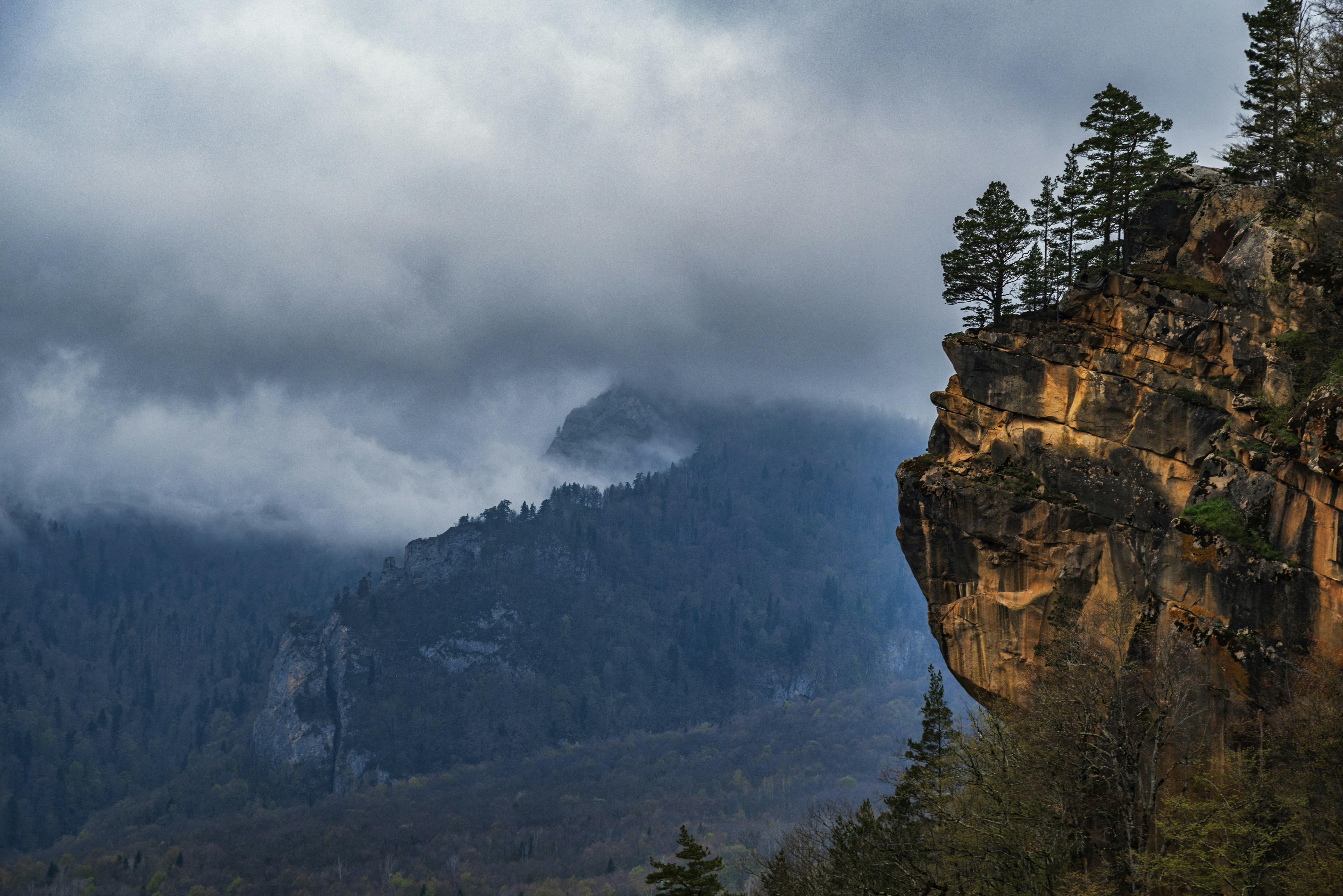 Cliff Edge under Mist: Sunrise Over Majestic Ridge
