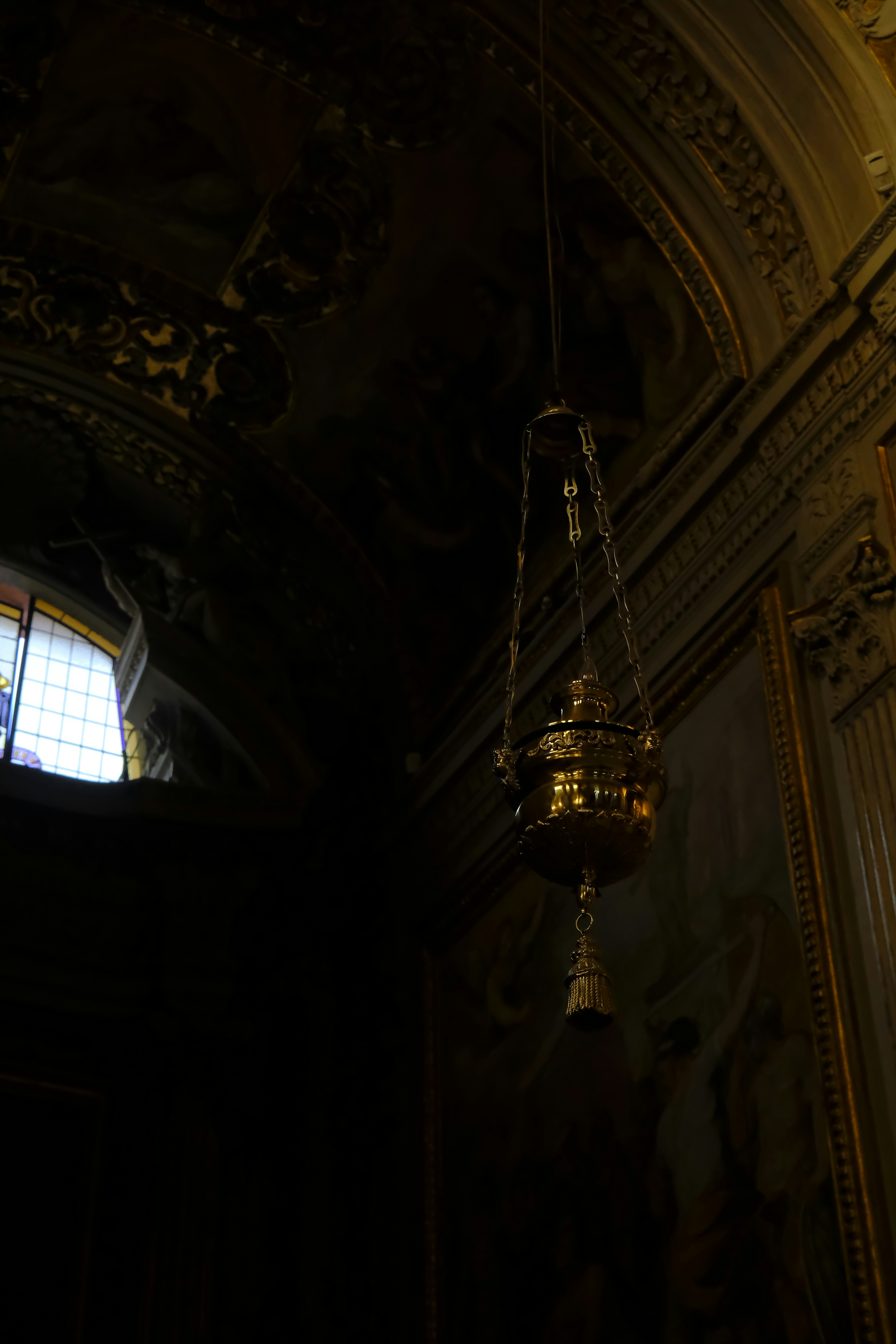 Hanging Lamp in a Dimly Lit Cathedral Niche