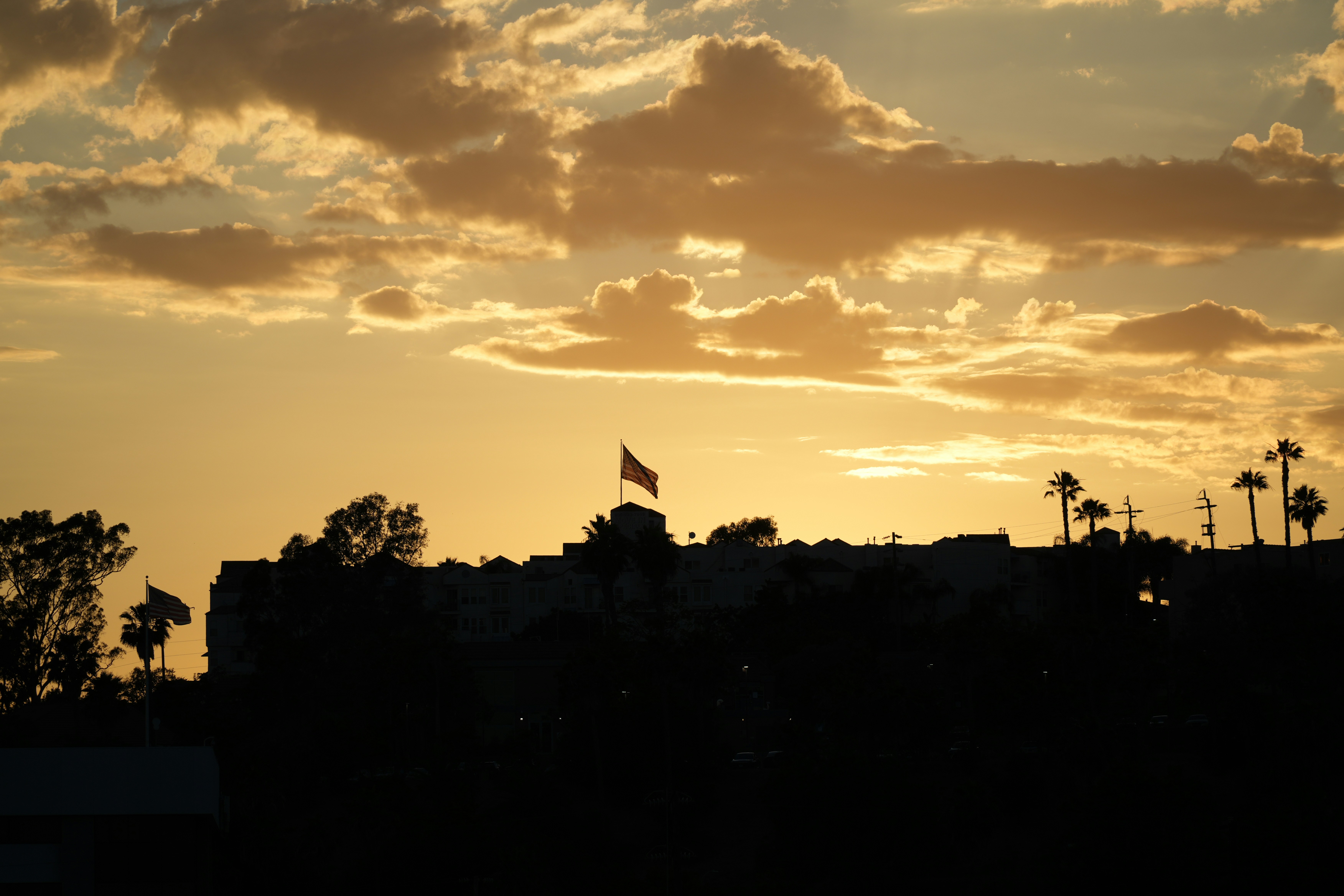 Silhouette at Sunset: Flag atop the Ridge